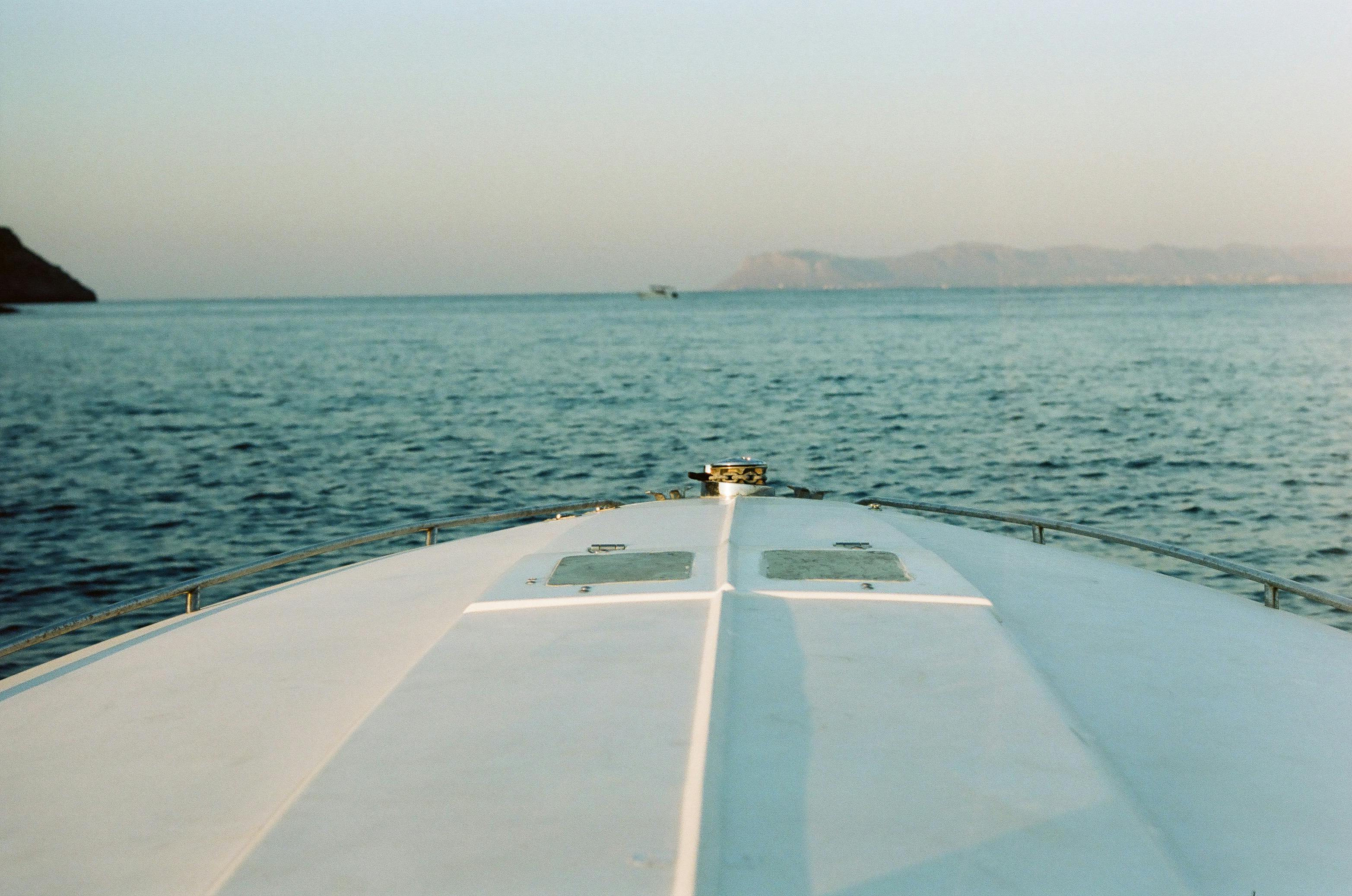 Boat on Water Near Seashore · Free Stock Photo