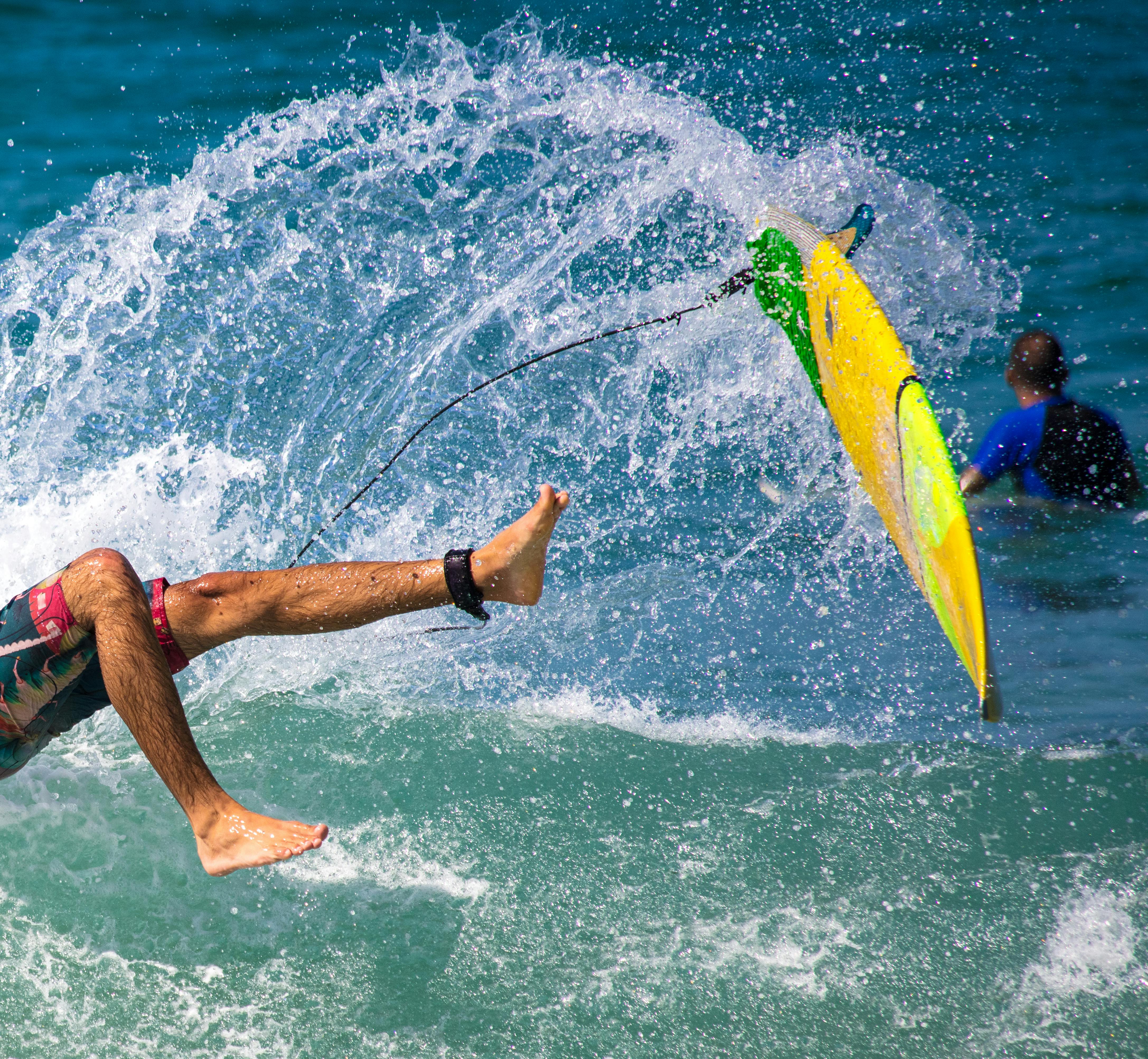 Legs of Surfer Falling Down in Water · Free Stock Photo