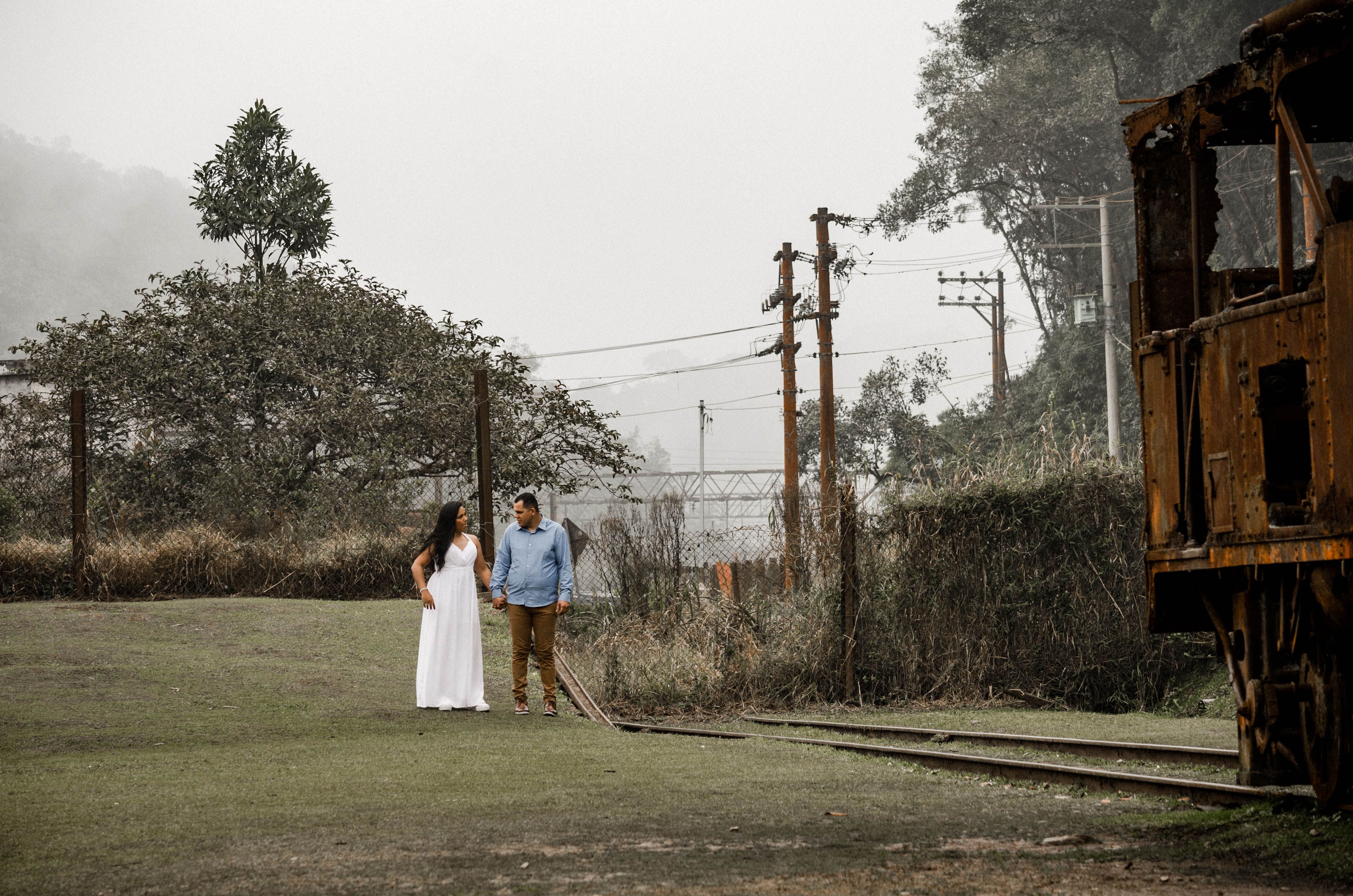 Man and Woman Walking on Train Rail · Free Stock Photo