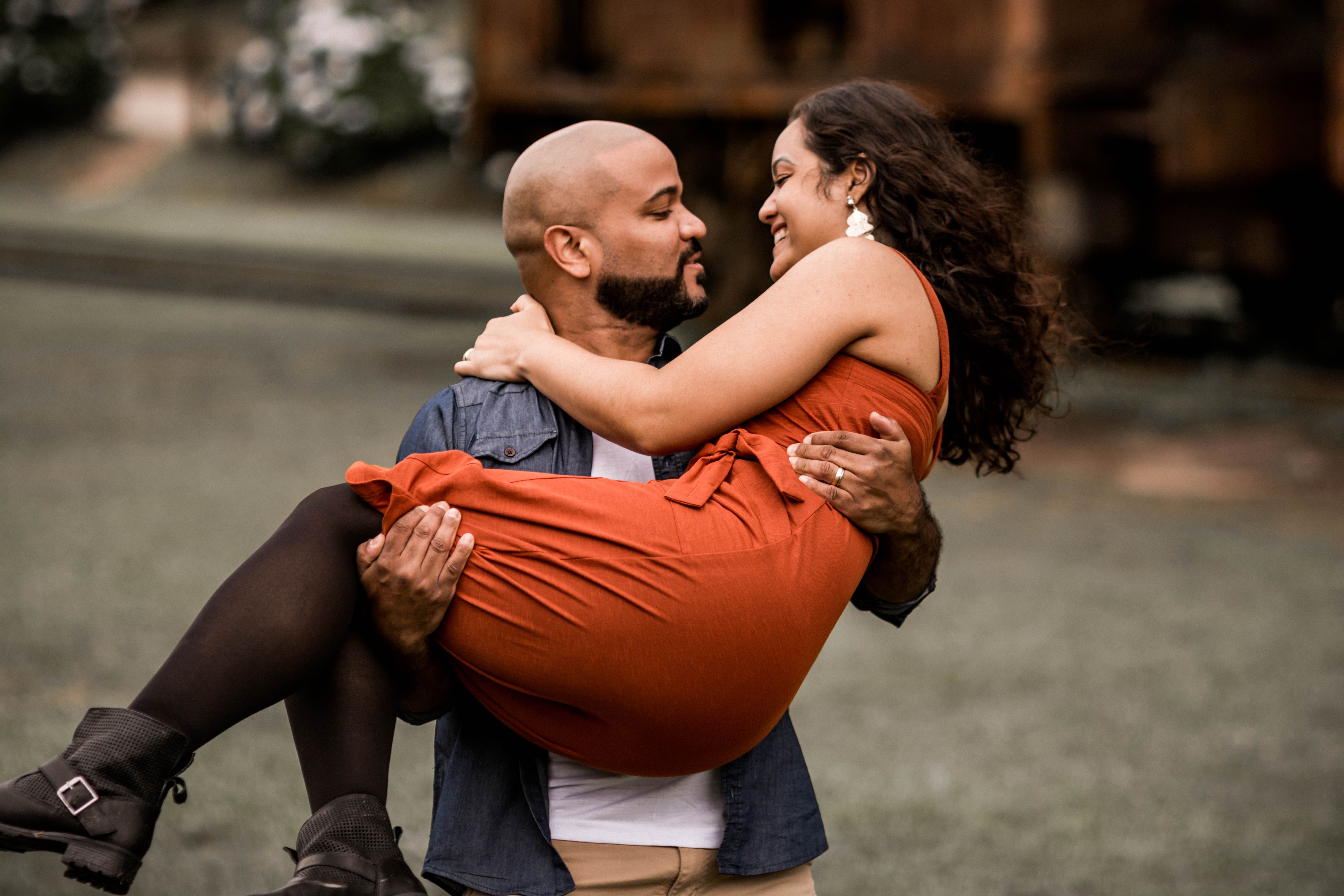 Smiling Man Carrying Woman in Hands · Free Stock Photo