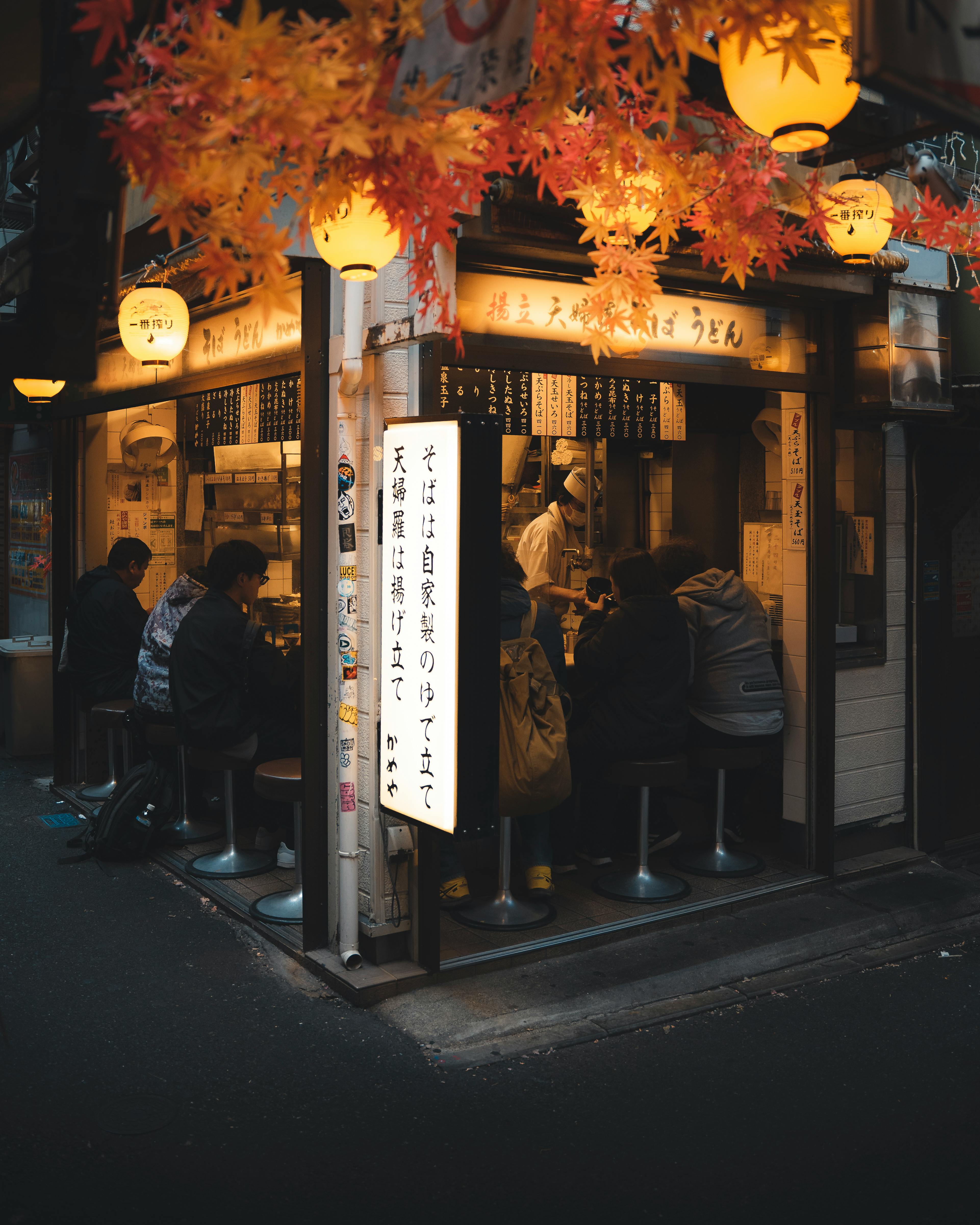 People Eating in a Small Japanese Restaurant · Free Stock Photo