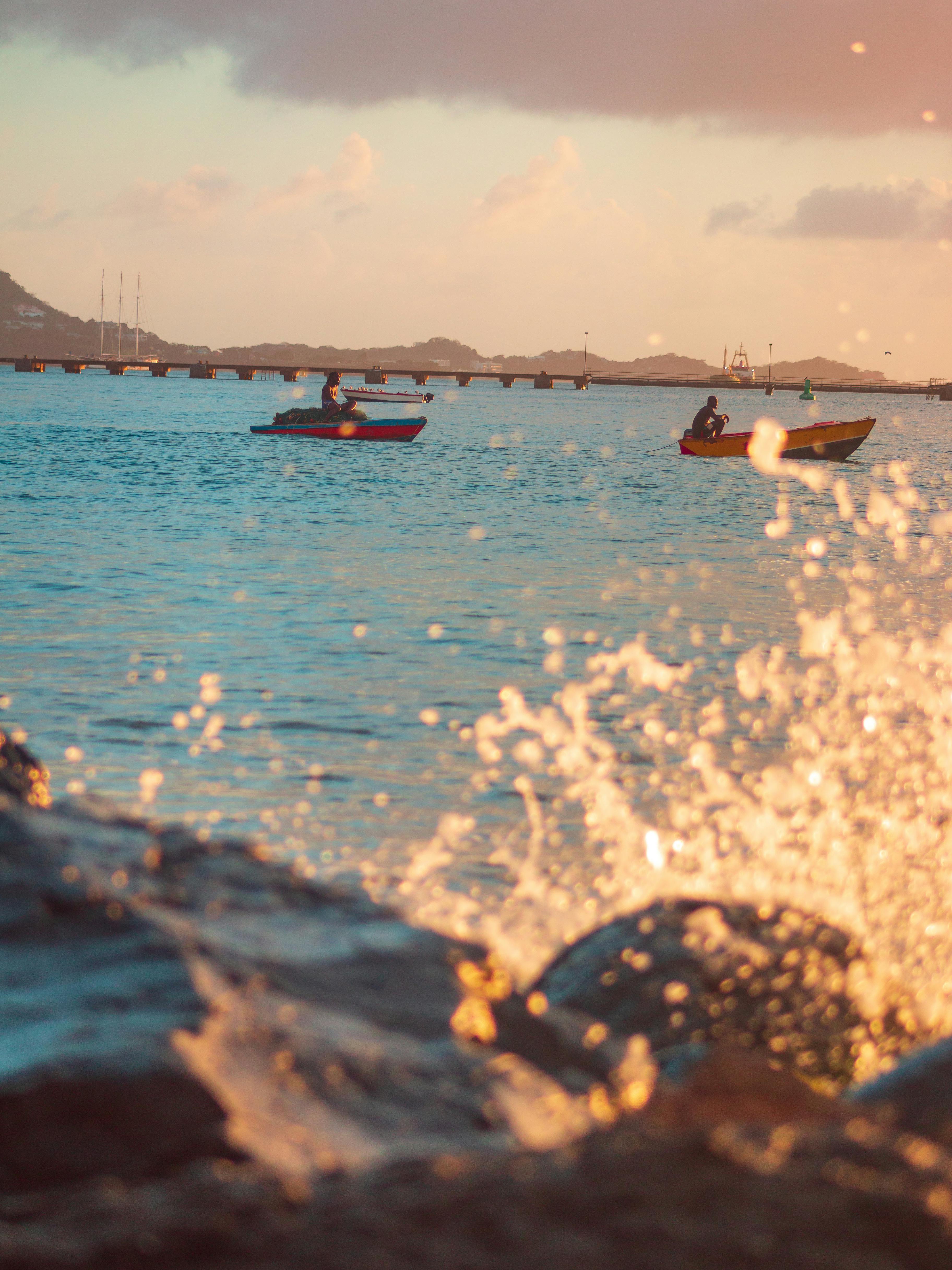 Splashing Water Against Boats on Sea · Free Stock Photo
