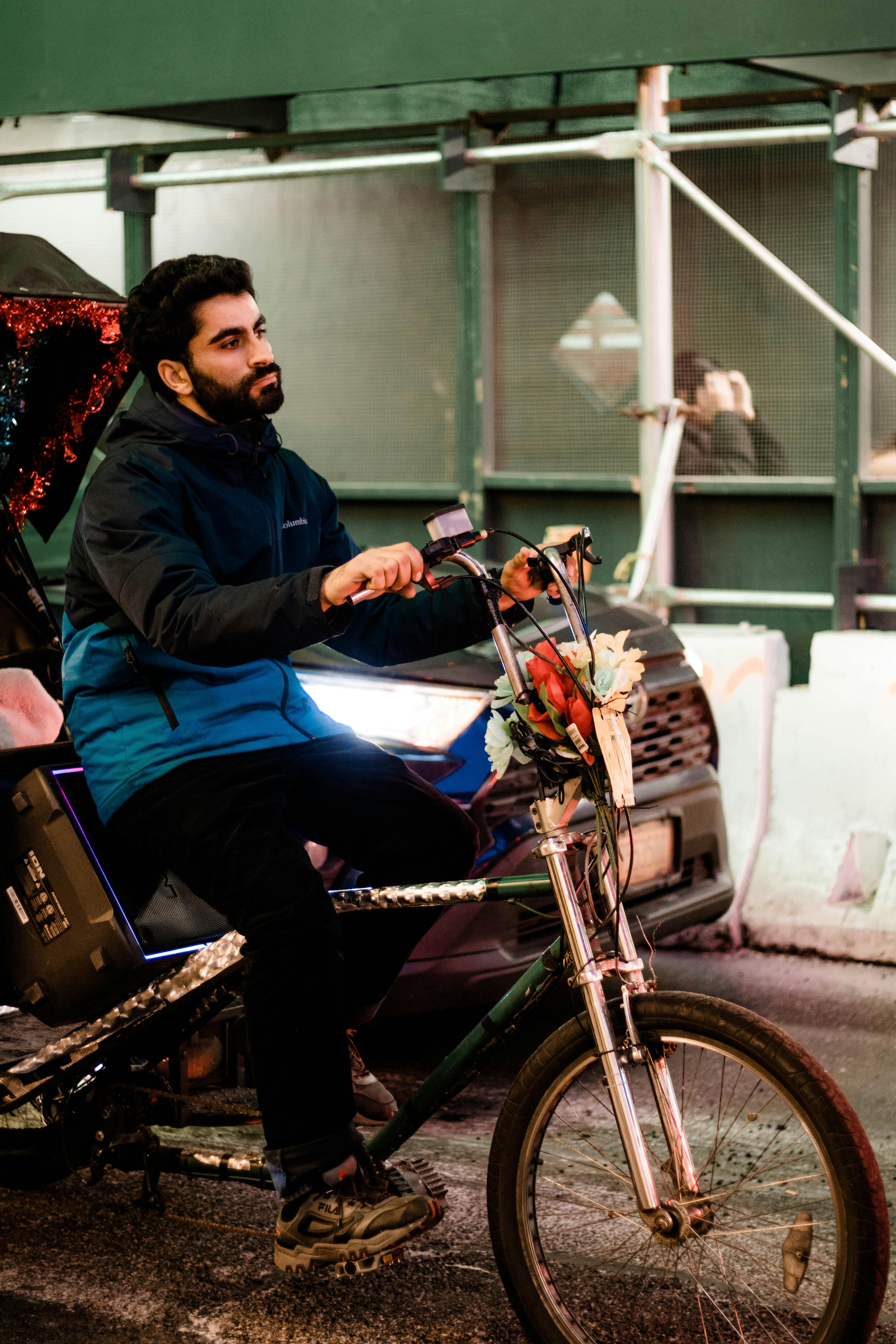 Photo of a Man Riding a Rickshaw · Free Stock Photo