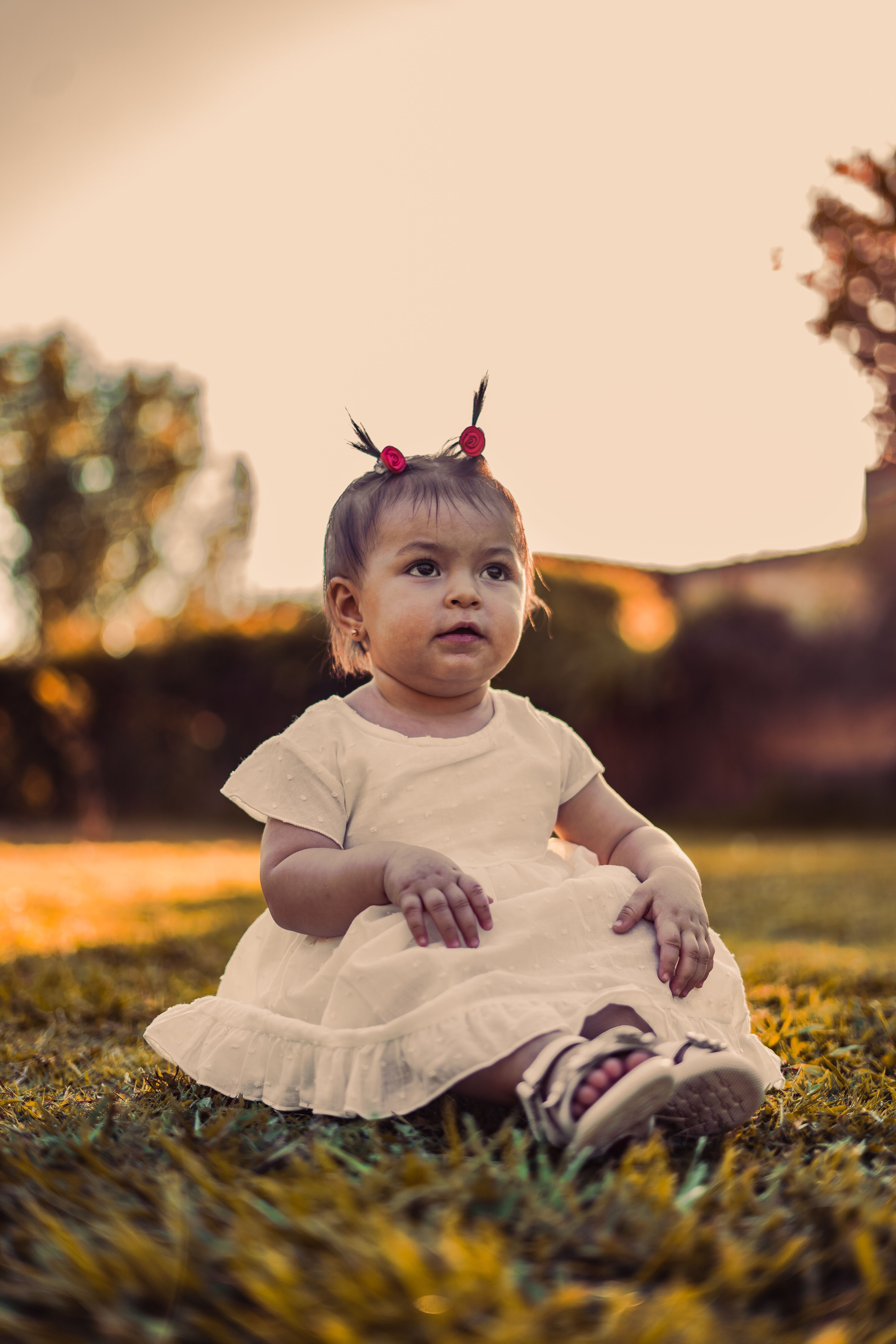 Cute Child Sitting on Ground on Sunset · Free Stock Photo