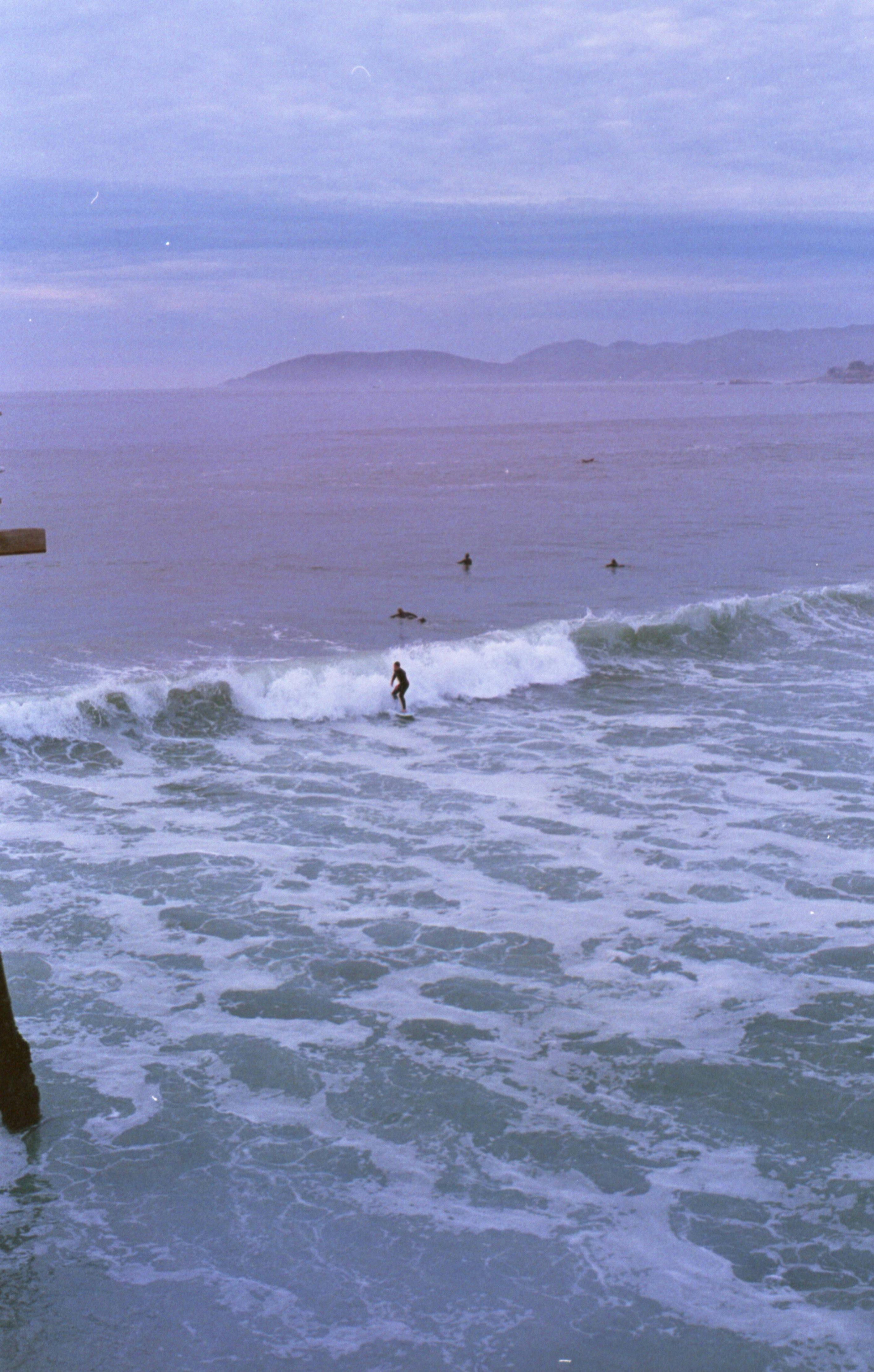 People Surfing on Waves on Seashore · Free Stock Photo