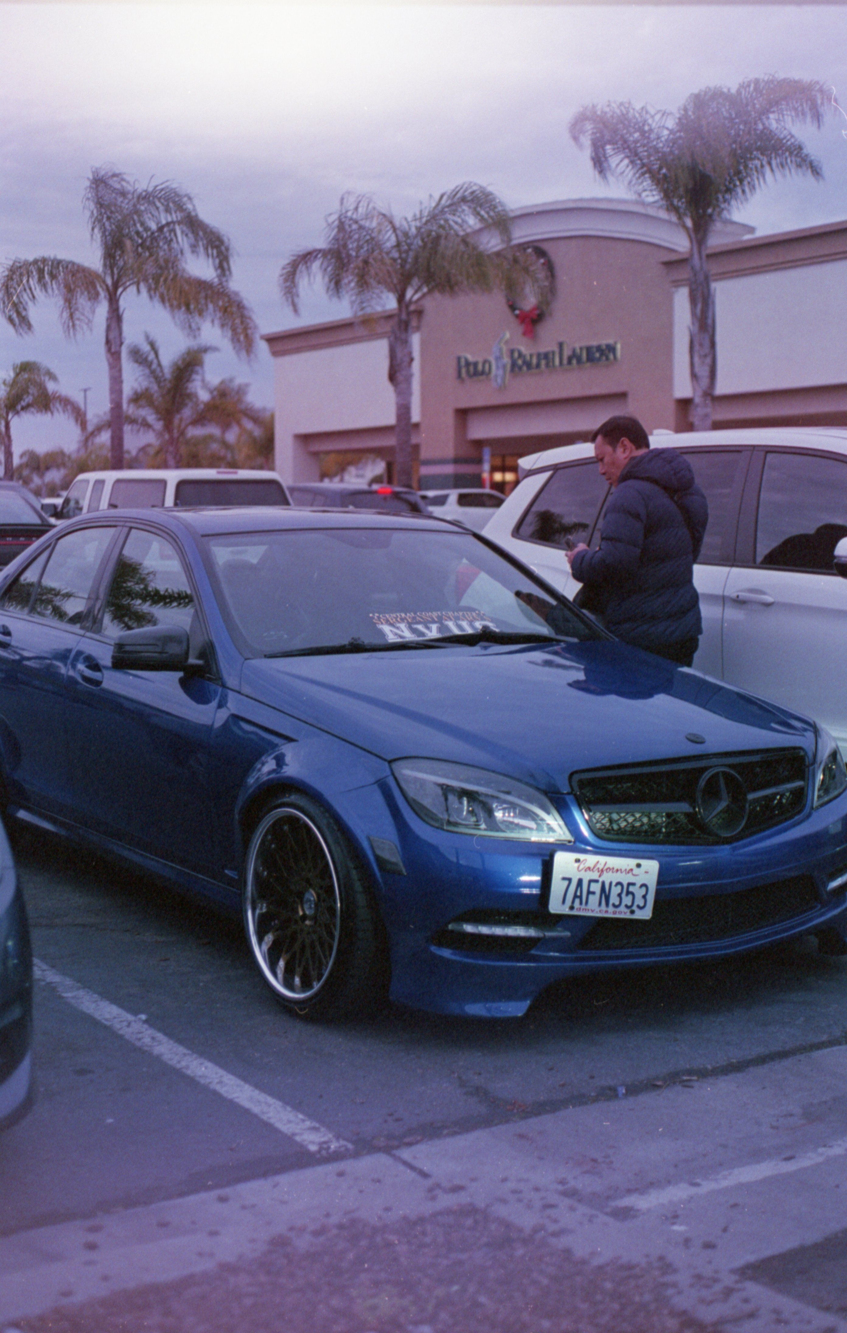 Man near Cars Parked on Parking Lot · Free Stock Photo