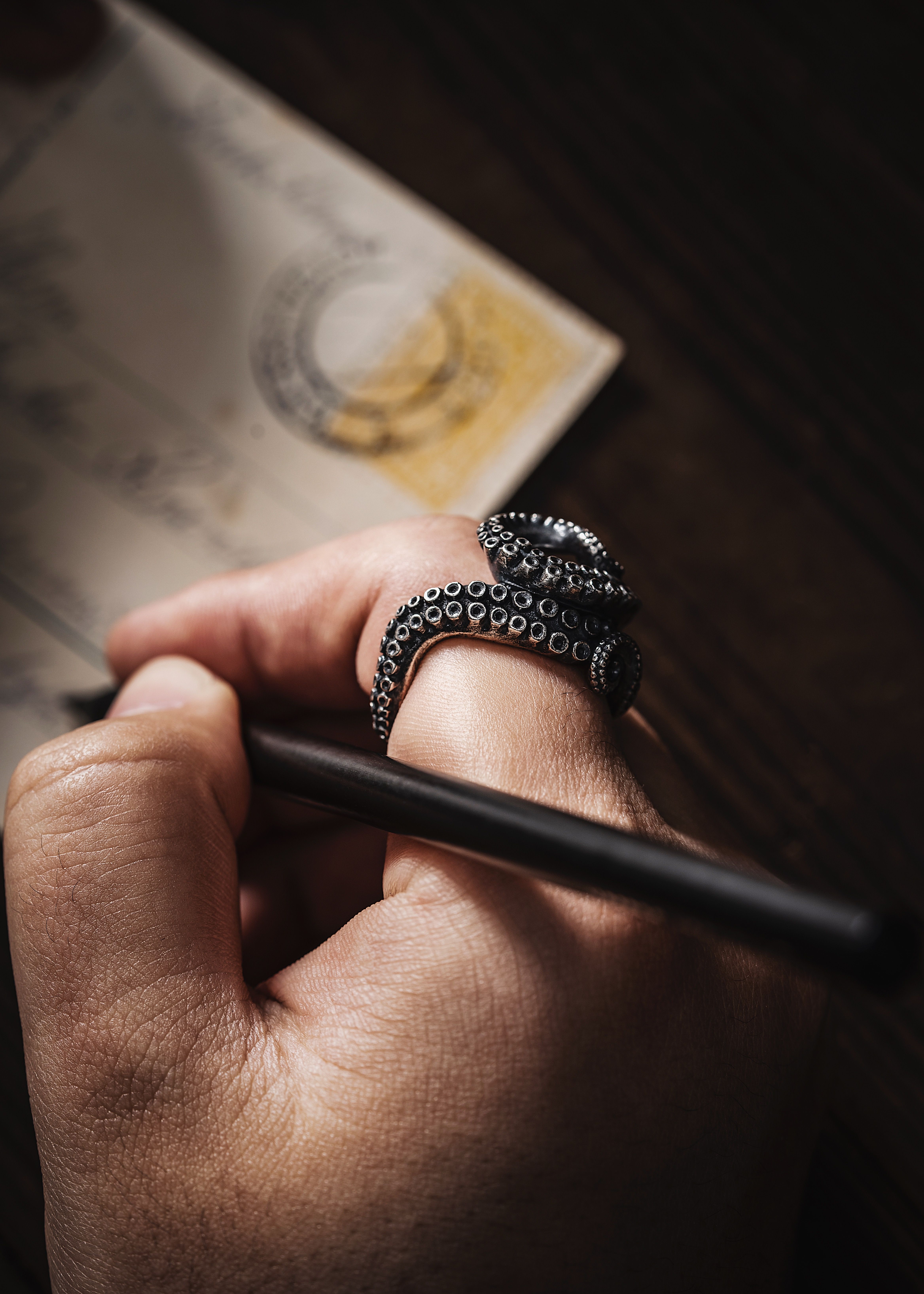 Close-up of a Man Wearing an Octopus Tentacle Ring and Writing on a ...
