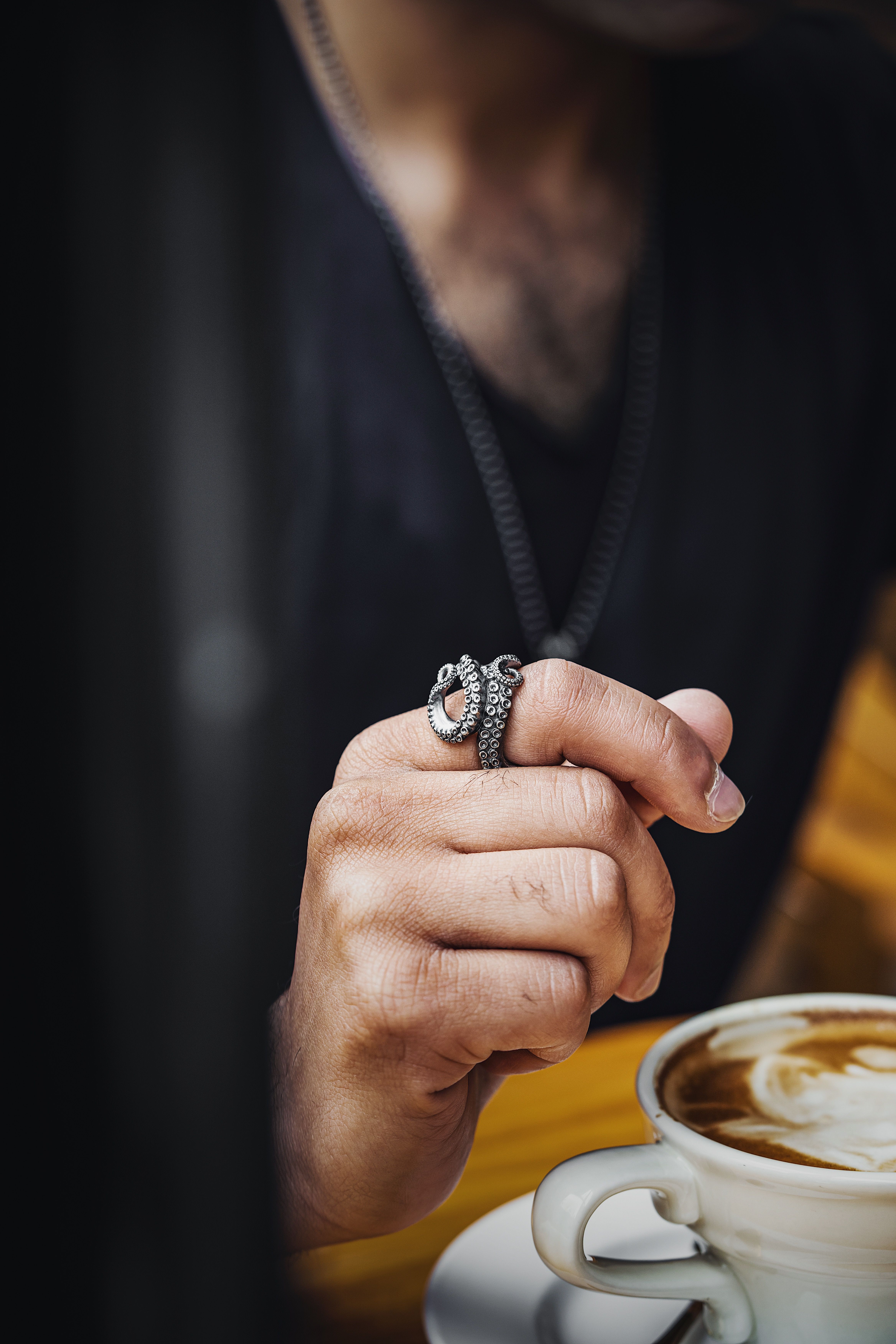 Close-up of Man Wearing an Octopus Tentacle Ring and Sitting by a Table ...