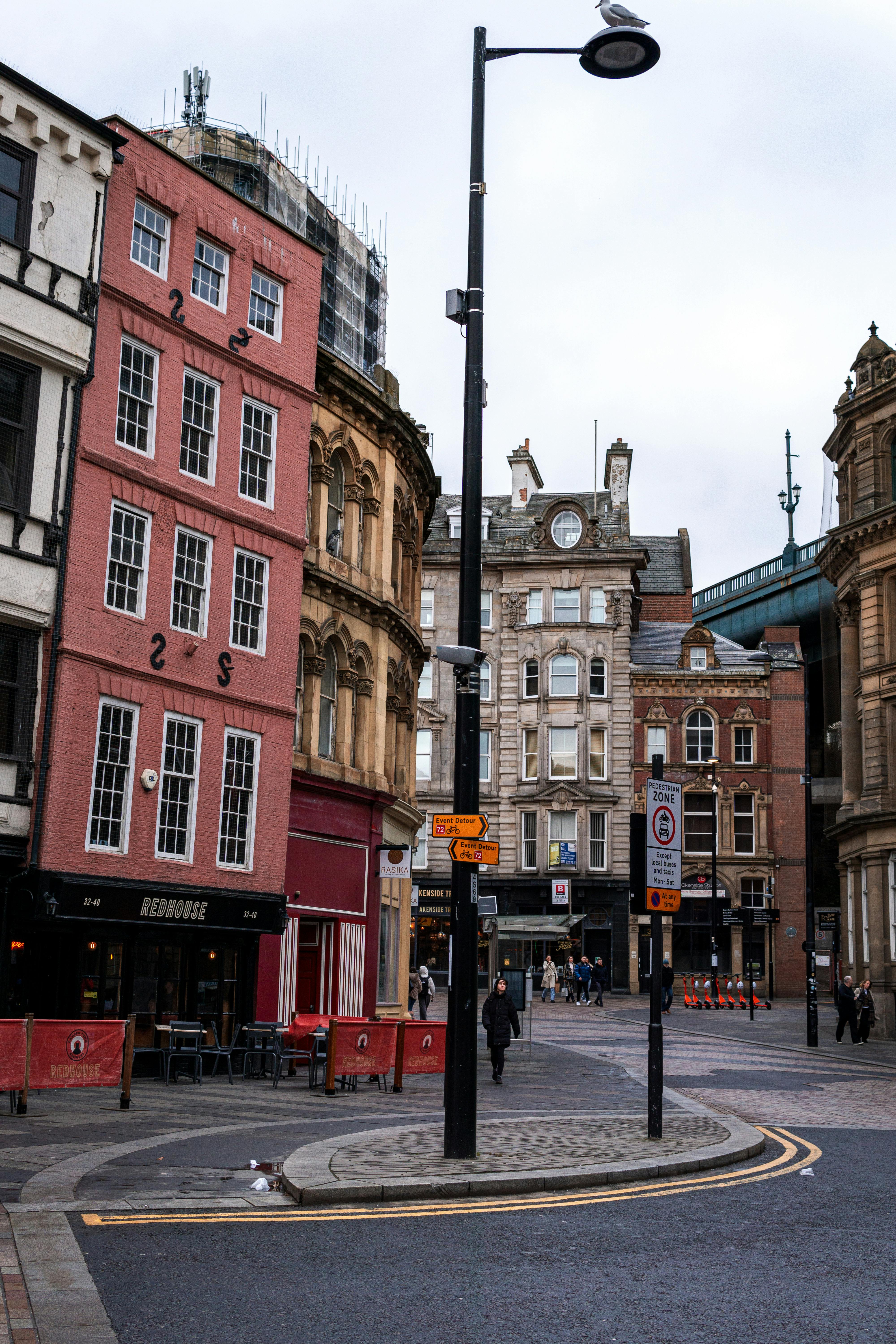 People Walking Between Buildings · Free Stock Photo