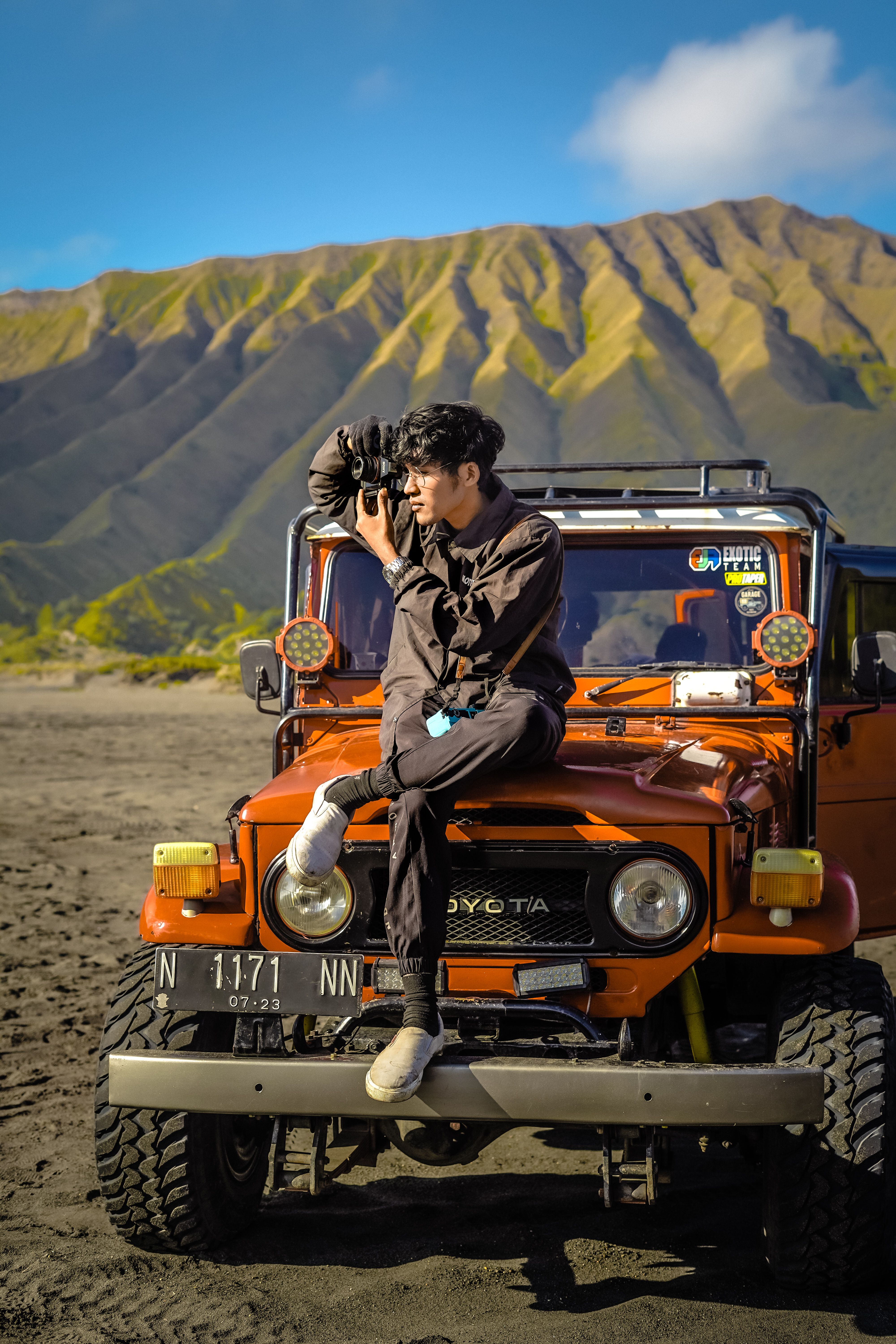 Man Sitting on the Hood of an Off Road Car and Taking a Picture · Free ...