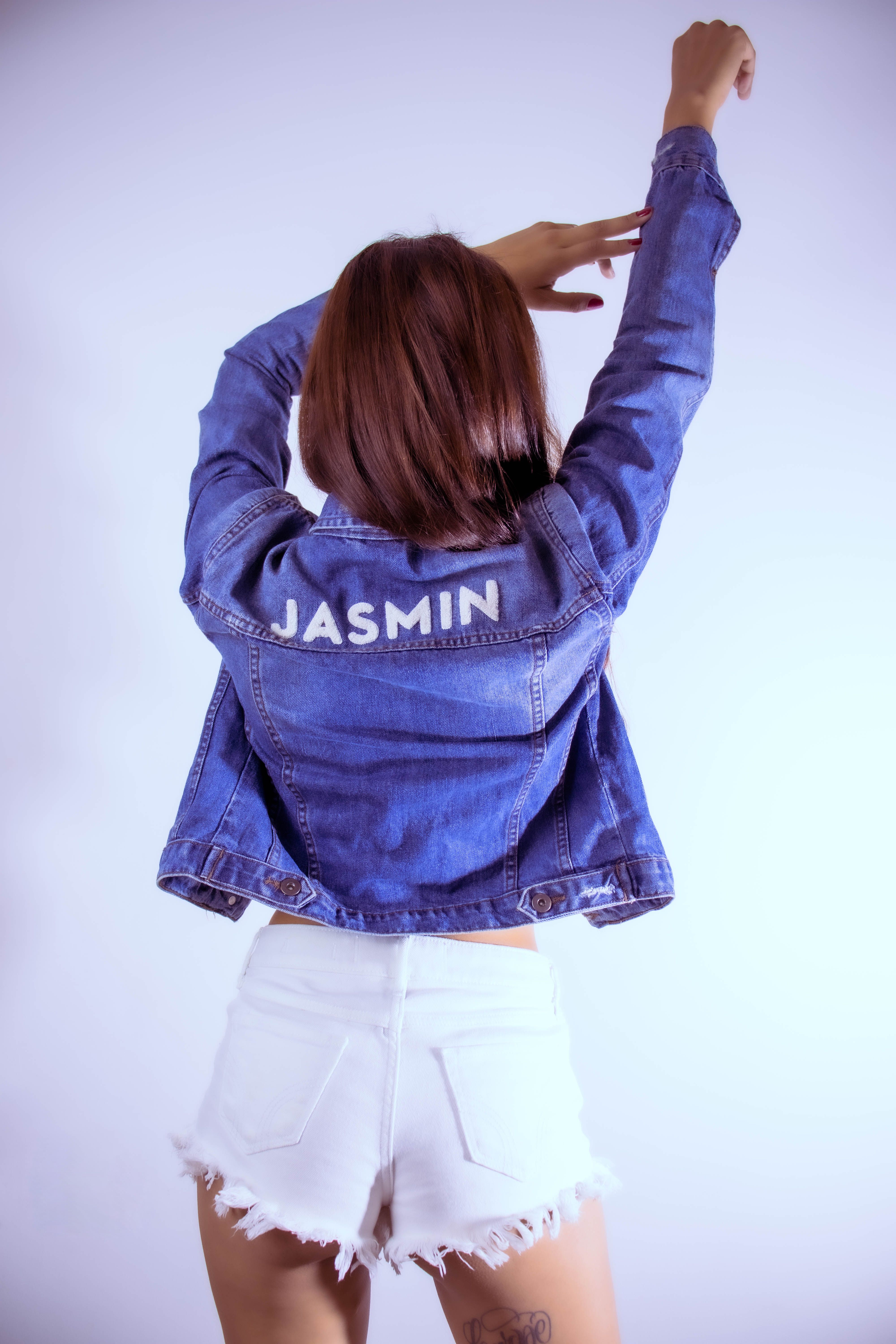 Woman in Jacket Posing with Arms Raised · Free Stock Photo