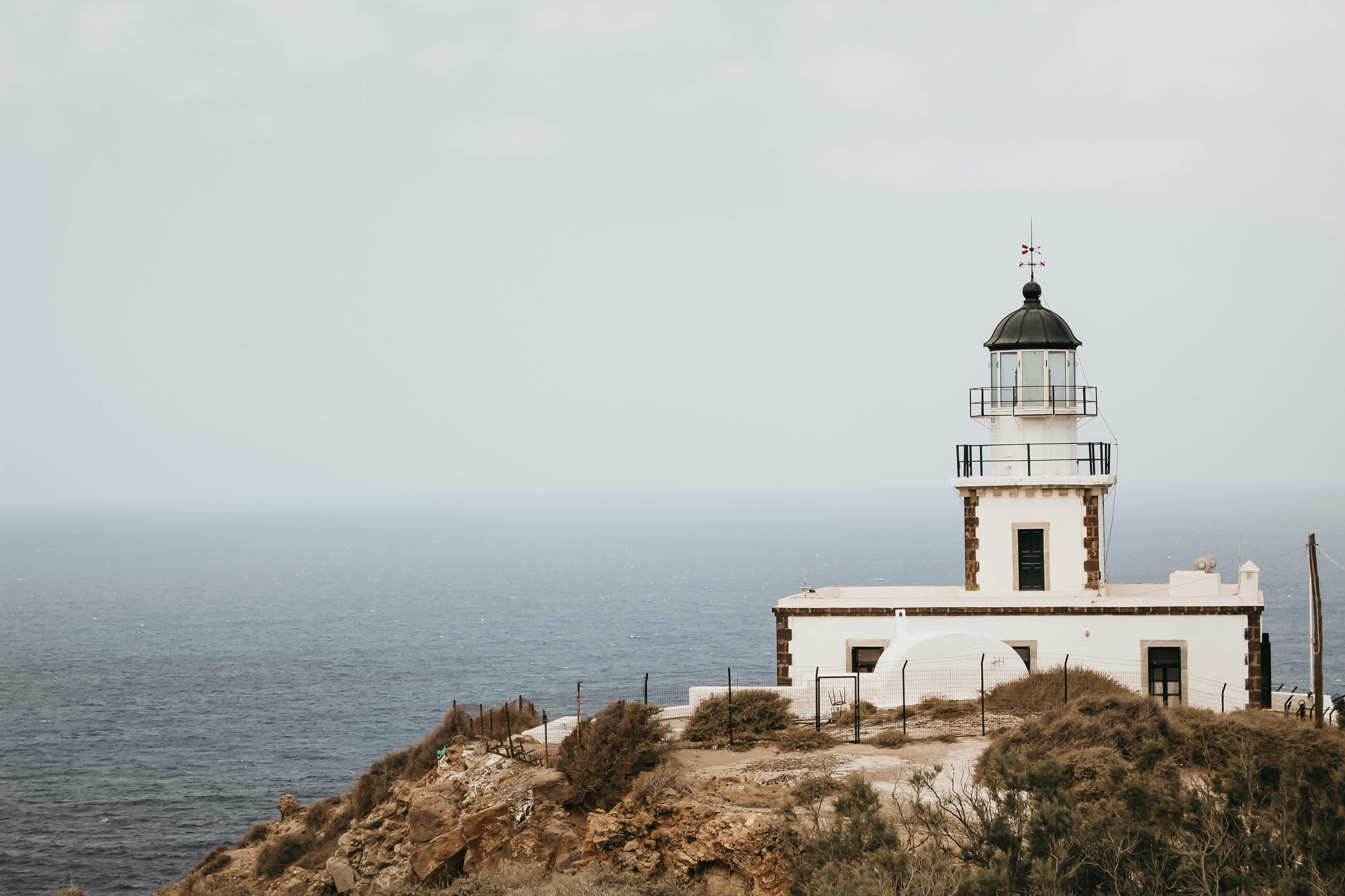 White Lighthouse On Cliff · Free Stock Photo