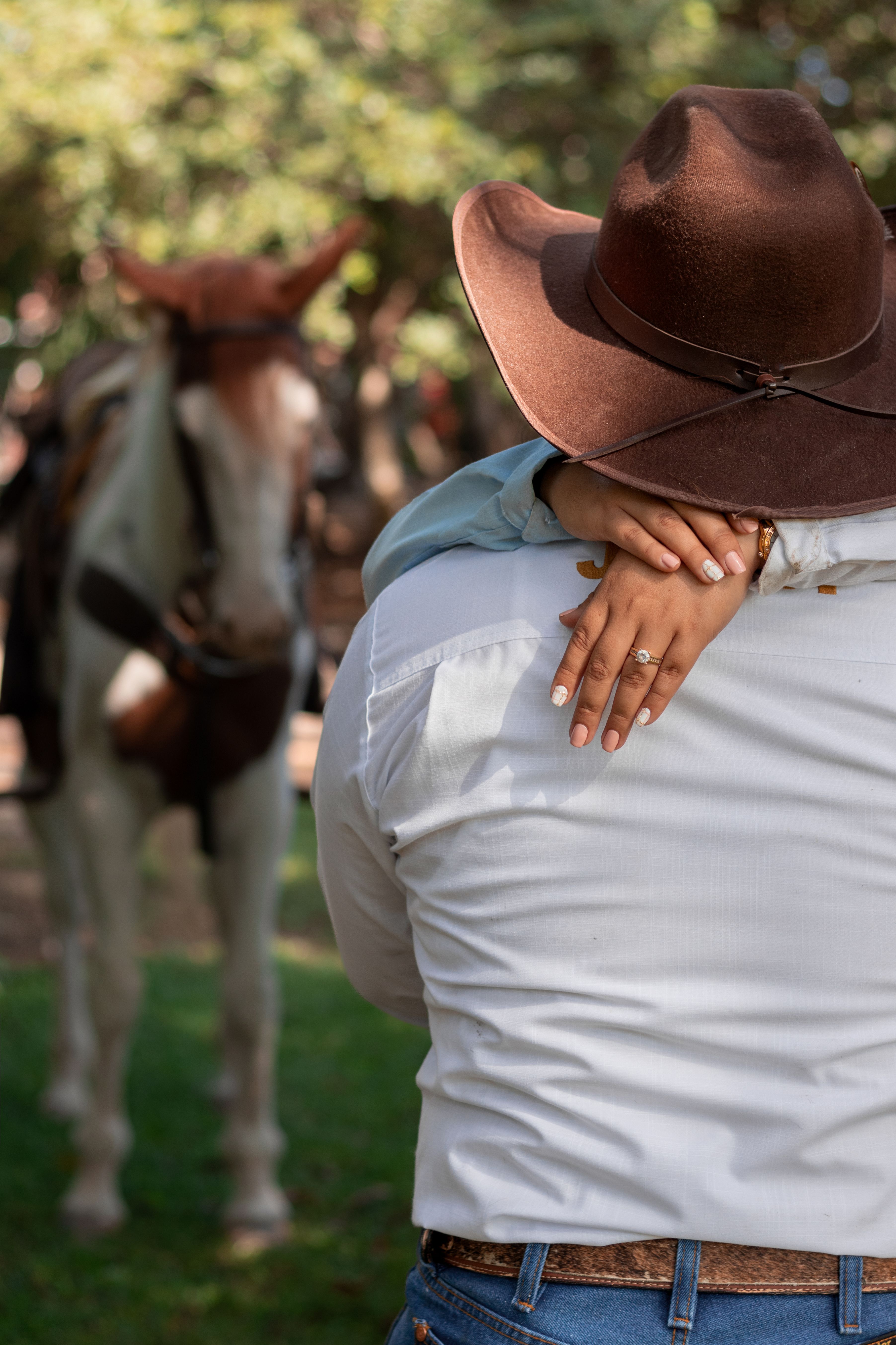 Back View of Woman Hugging a Man Wearing a Cowboy Hat and Standing on a ...