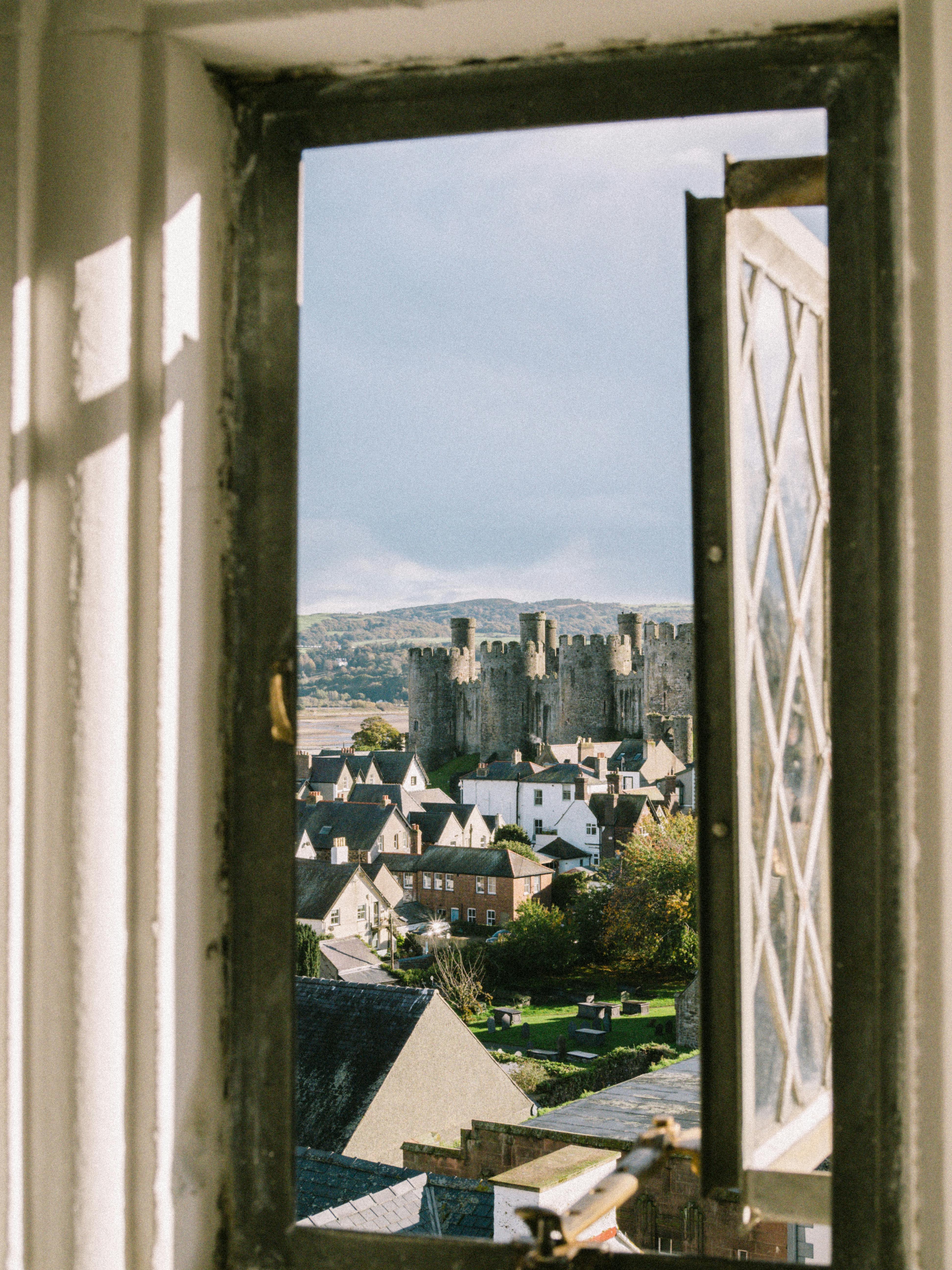 Castle and Surrounding Houses through Vintage Window · Free Stock Photo