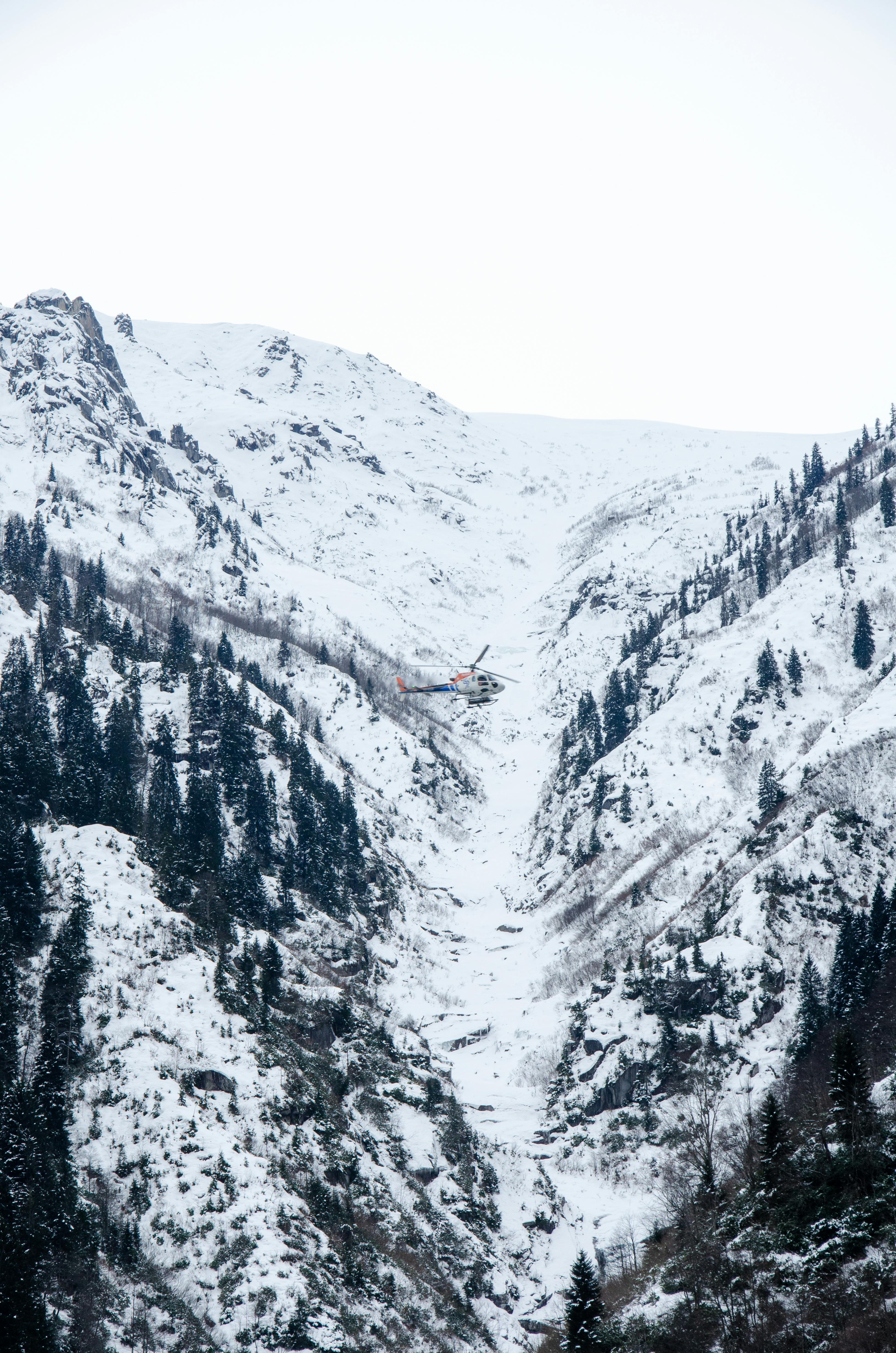 Helicopter Flying over Valley in Snow · Free Stock Photo