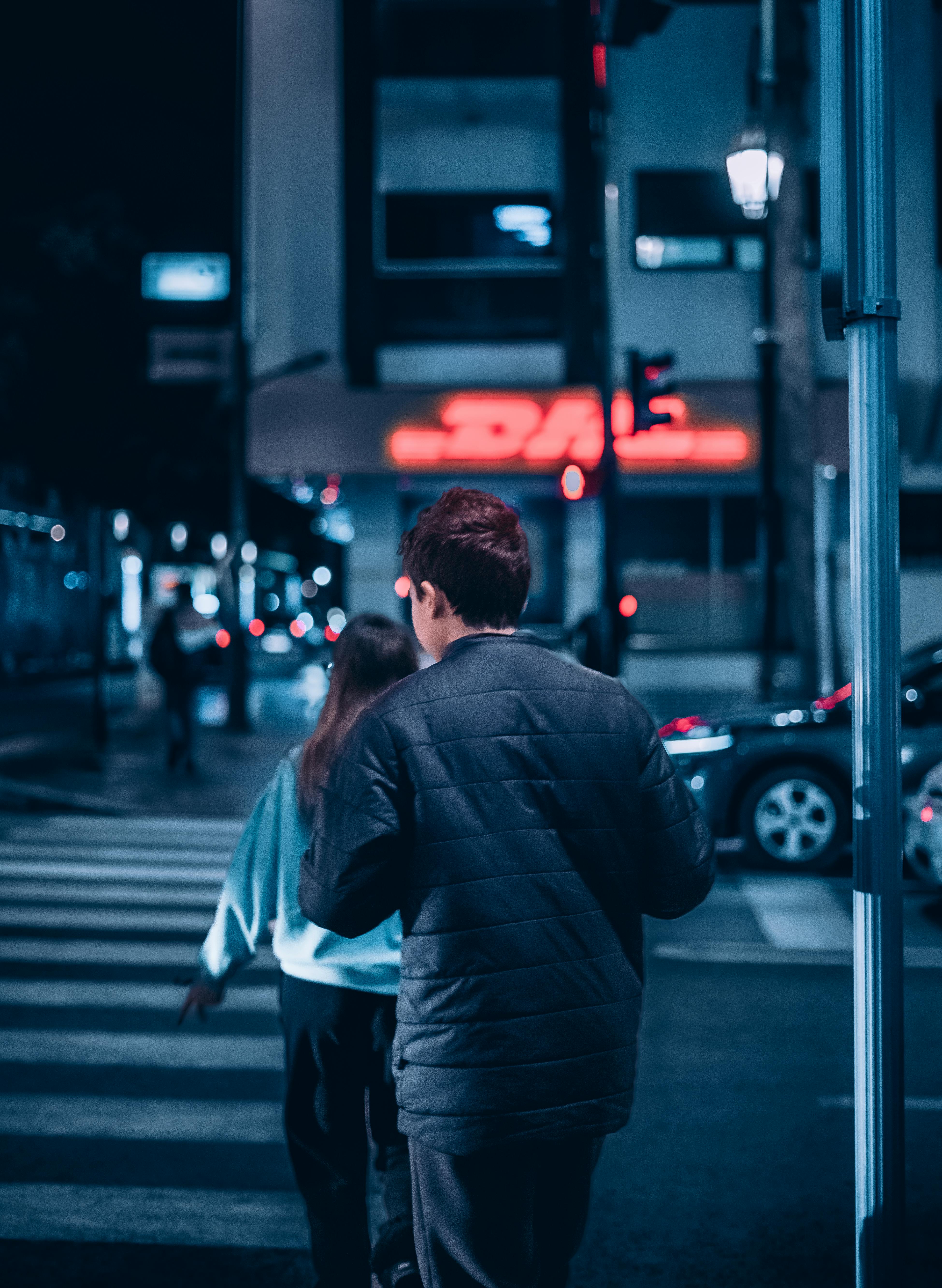 Back View of Pedestrians on a Crosswalk in City at Night · Free Stock Photo