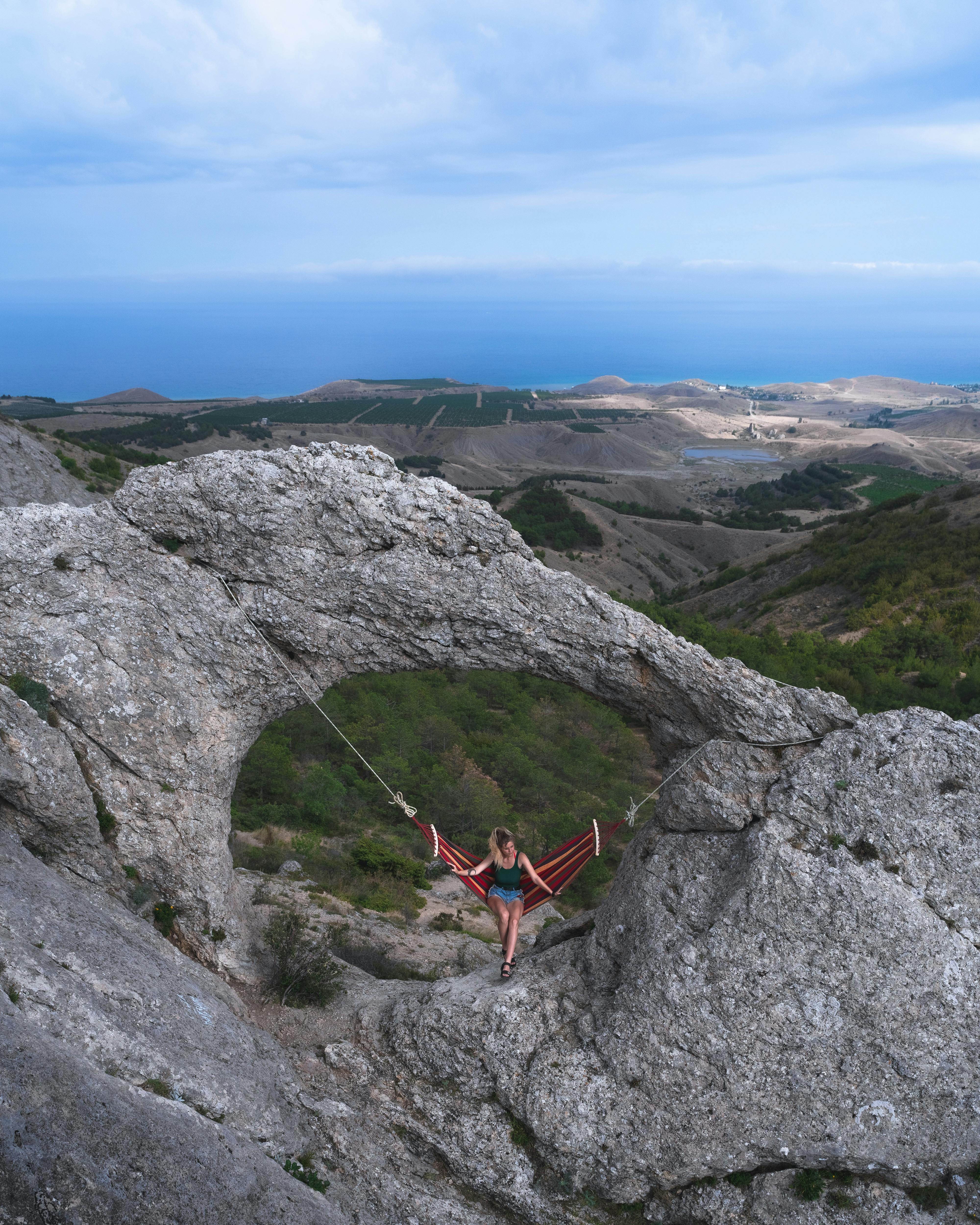 Woman in Hammock at Rock Formation in Mountains · Free Stock Photo
