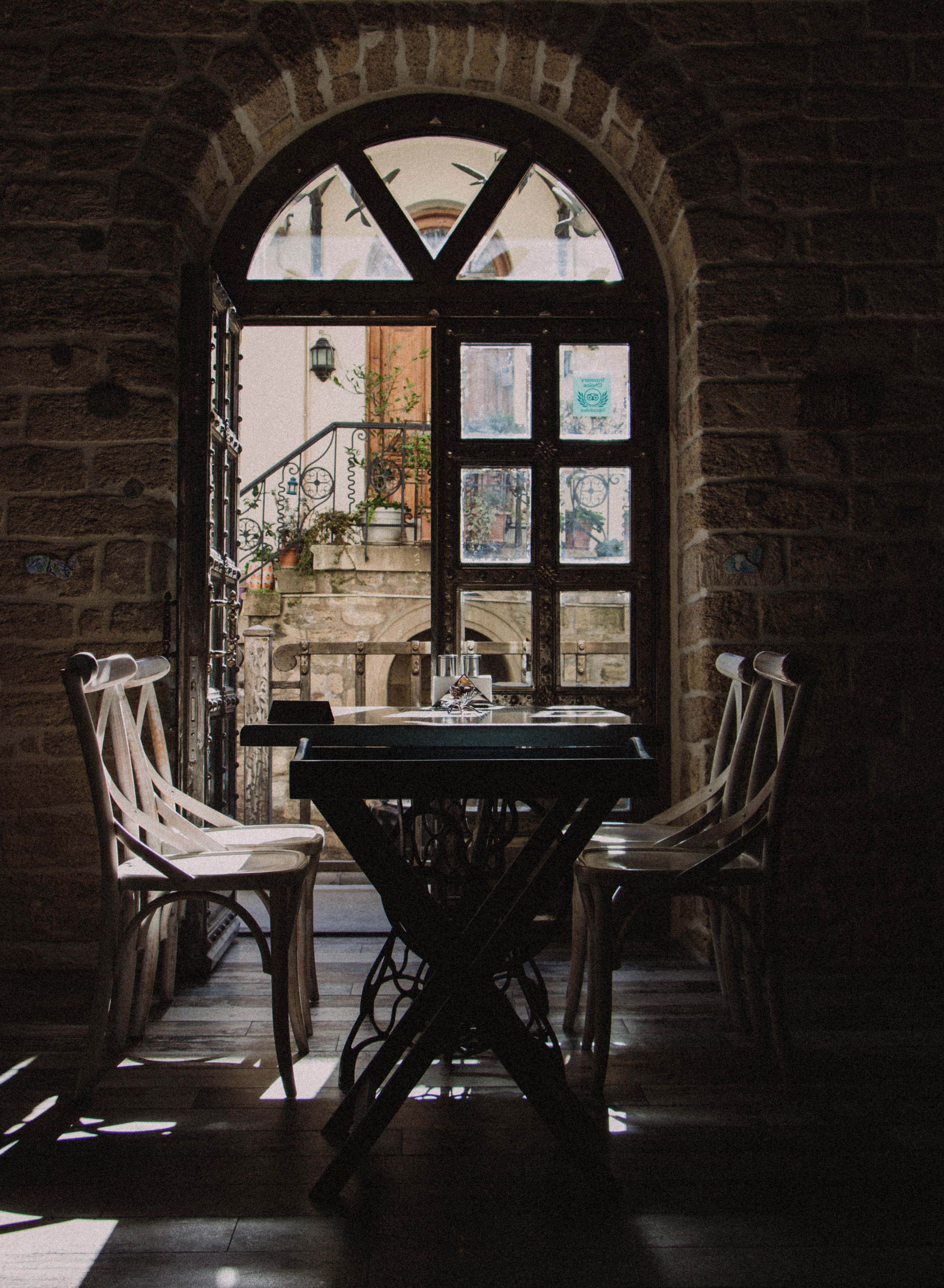 A Table with Chairs Beside the Window · Free Stock Photo
