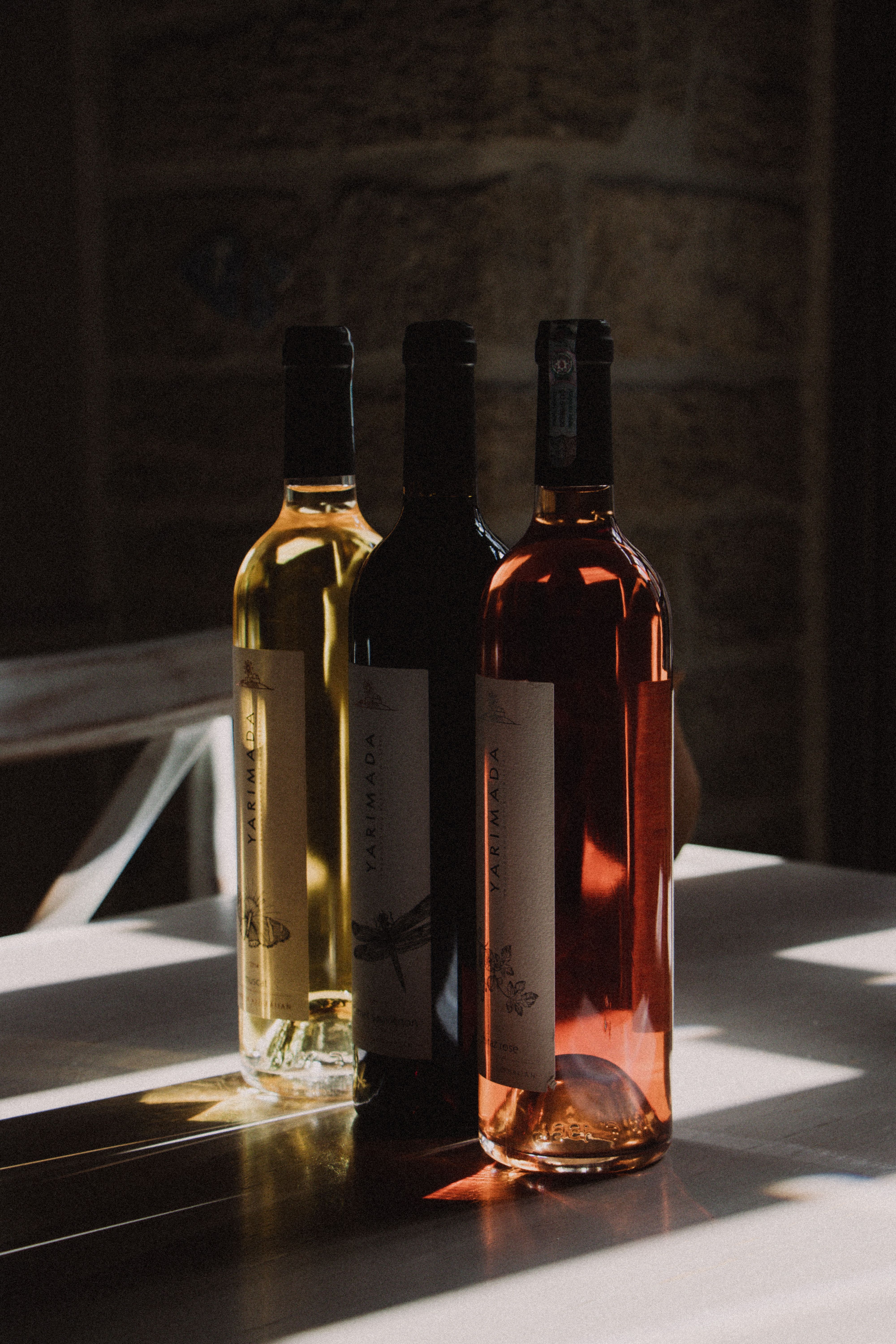 Bottles of Wine and Wine Glasses on a White Table · Free Stock Photo