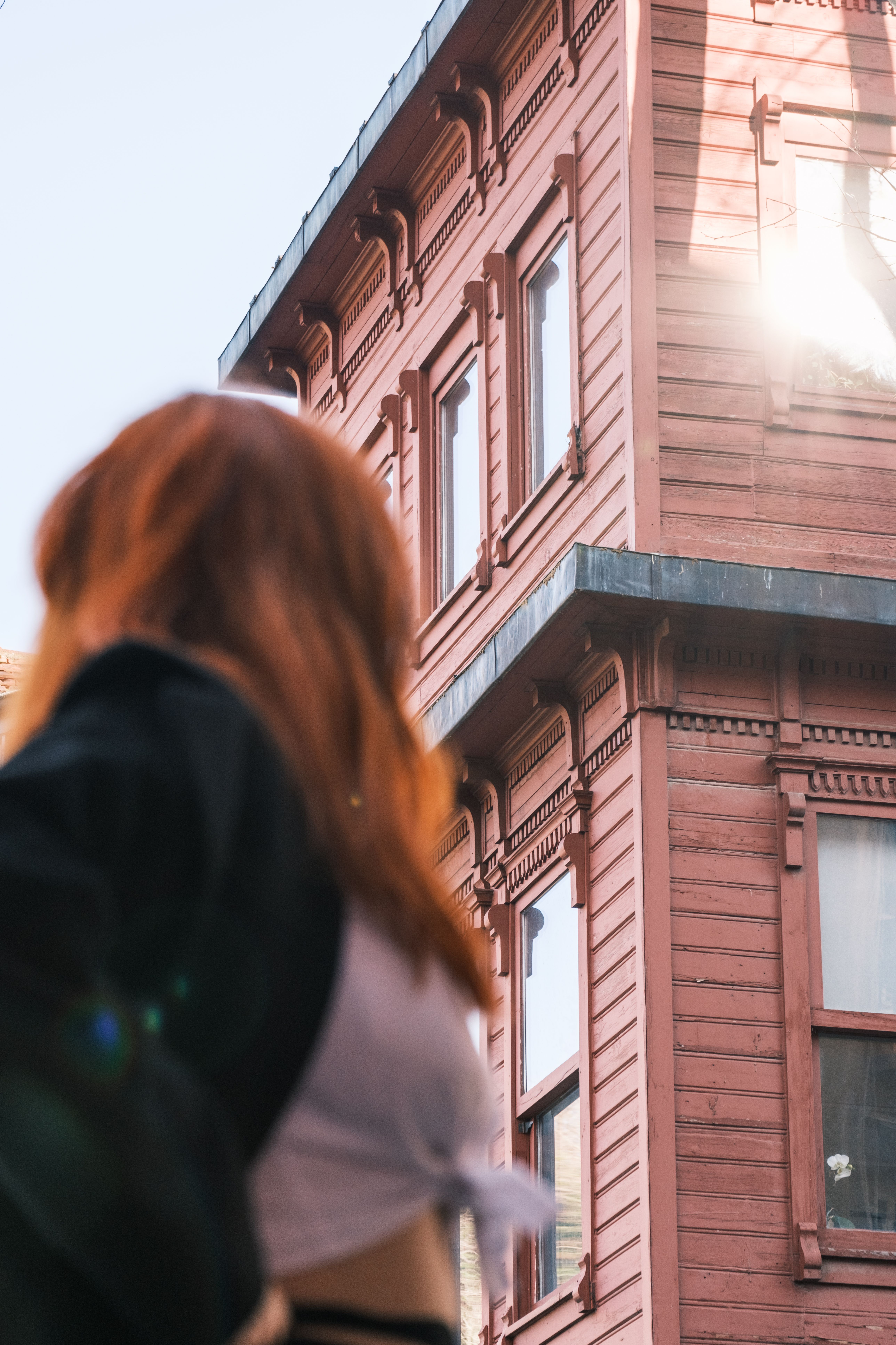 Woman Looking Toward a Traditional Building · Free Stock Photo