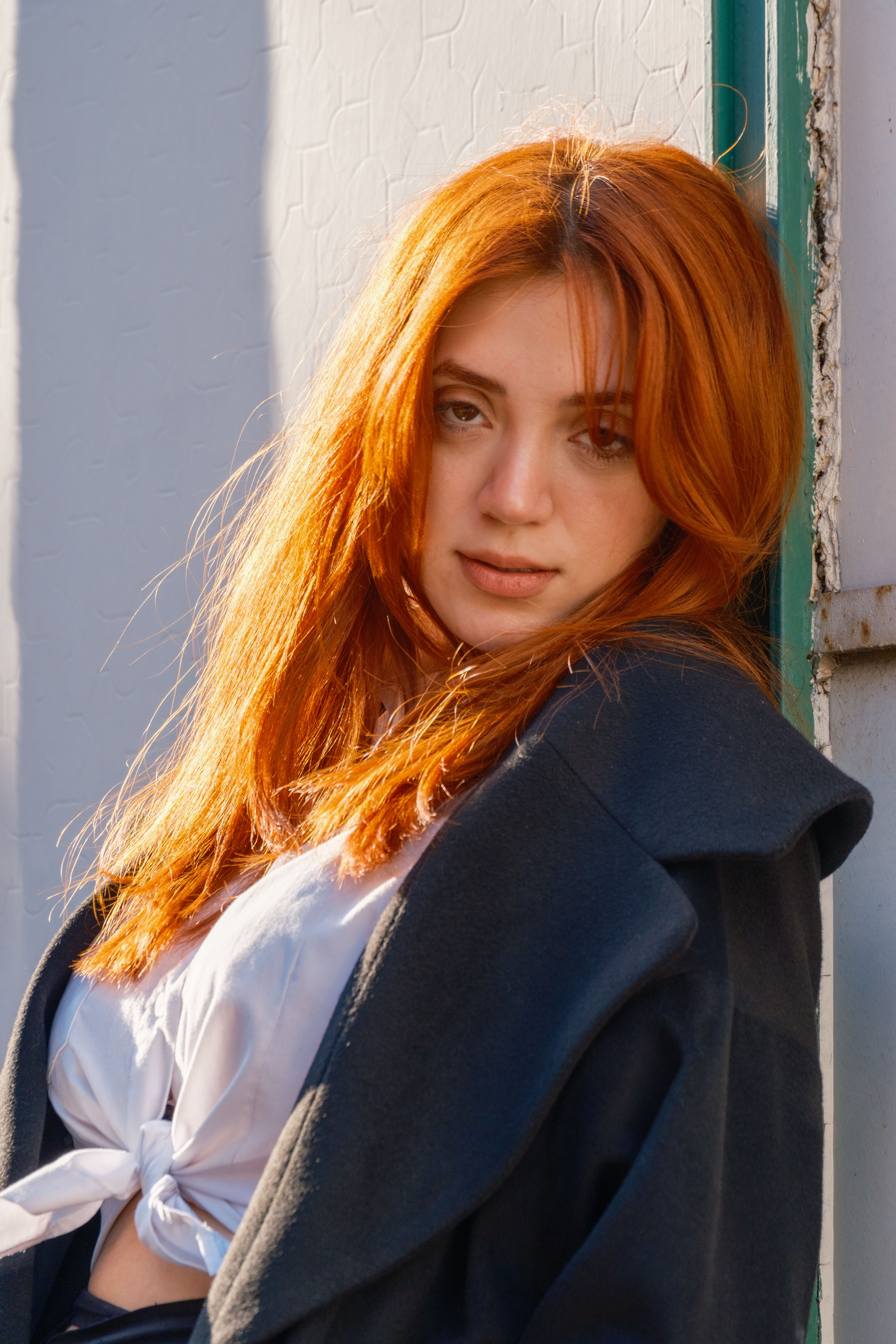 Young Redhead Woman Posing near Stone Wall · Free Stock Photo