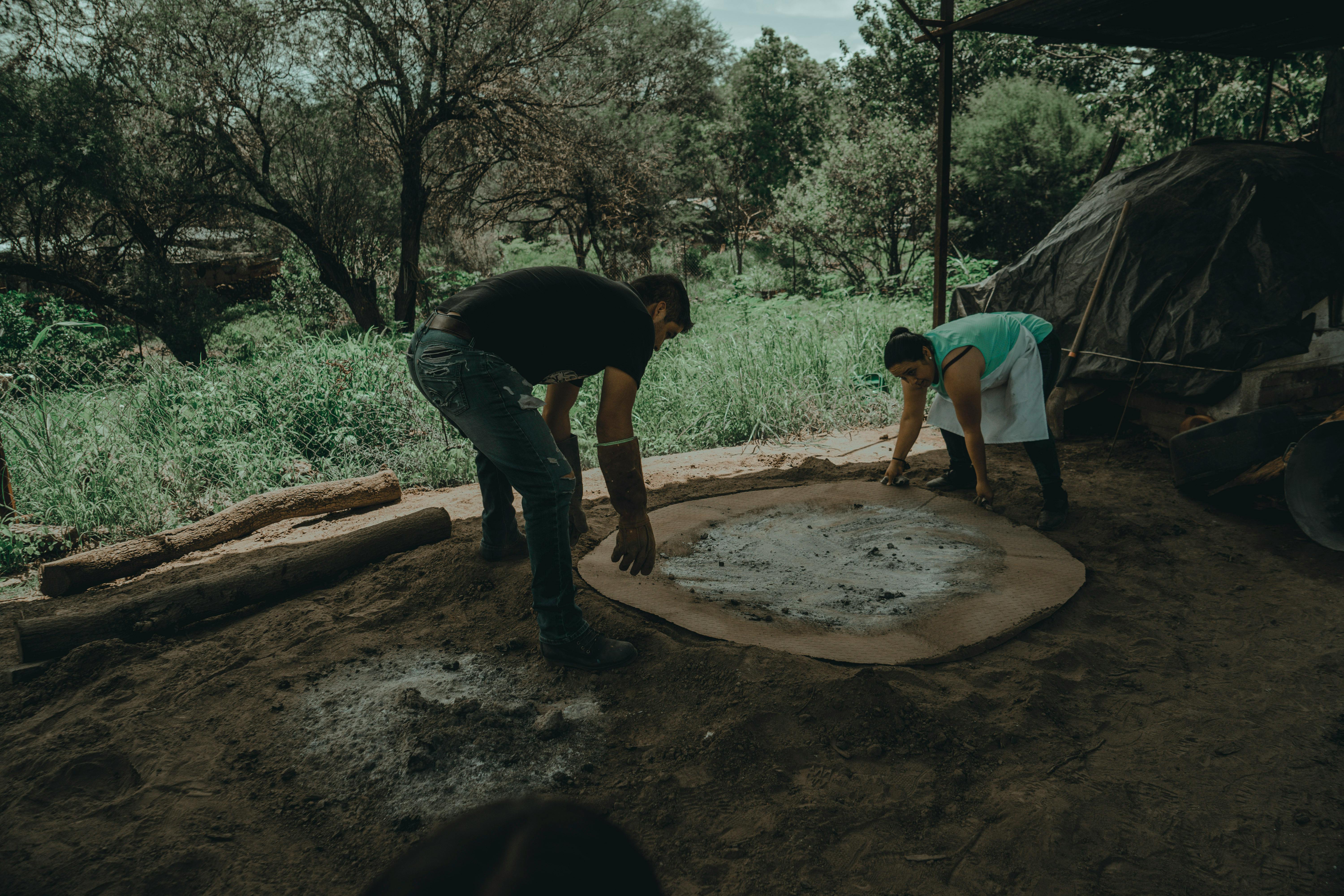 Man and Woman Cleaning the Ashes from an Outdoor Fireplace · Free Stock ...