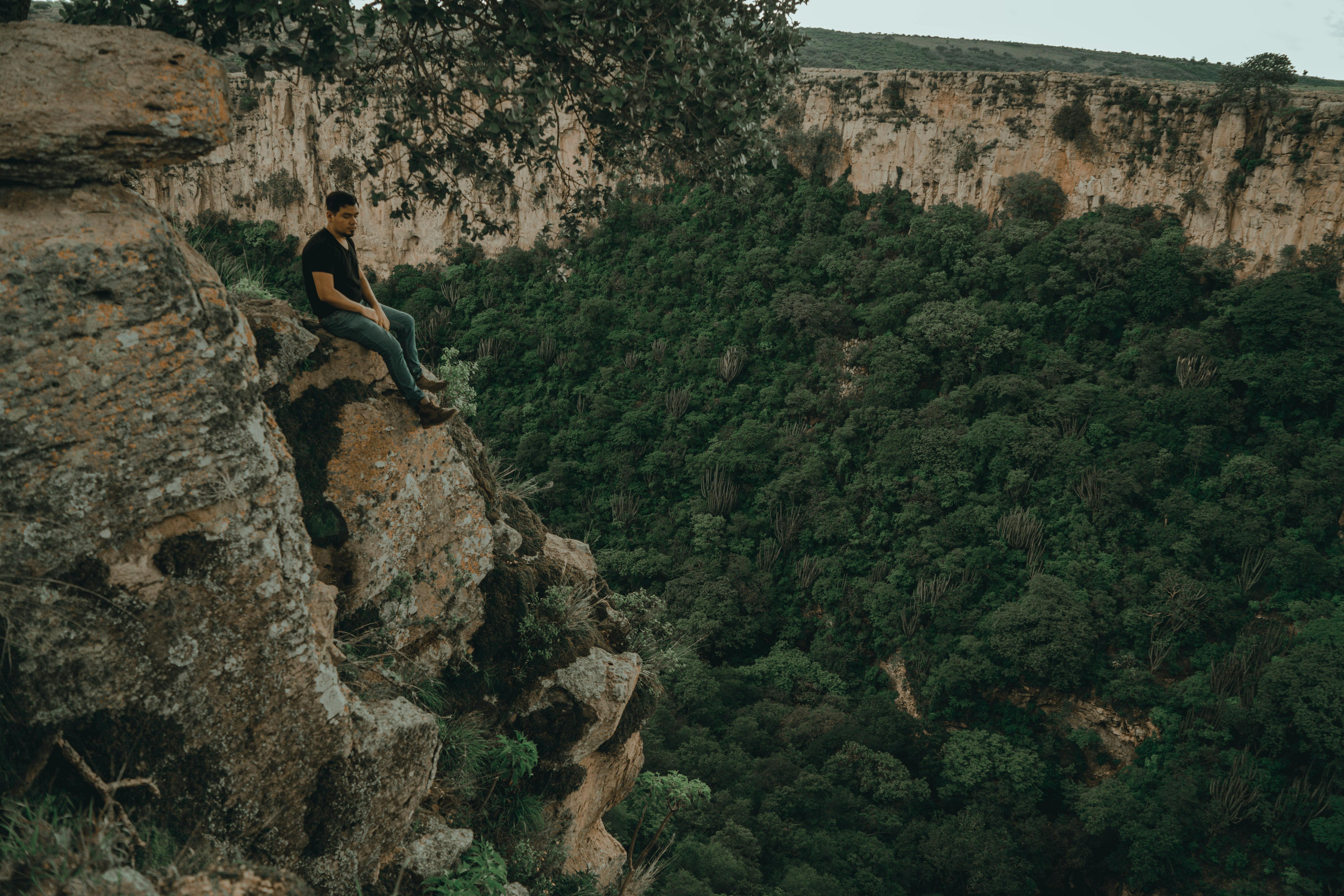 Man Sitting on Cliff · Free Stock Photo