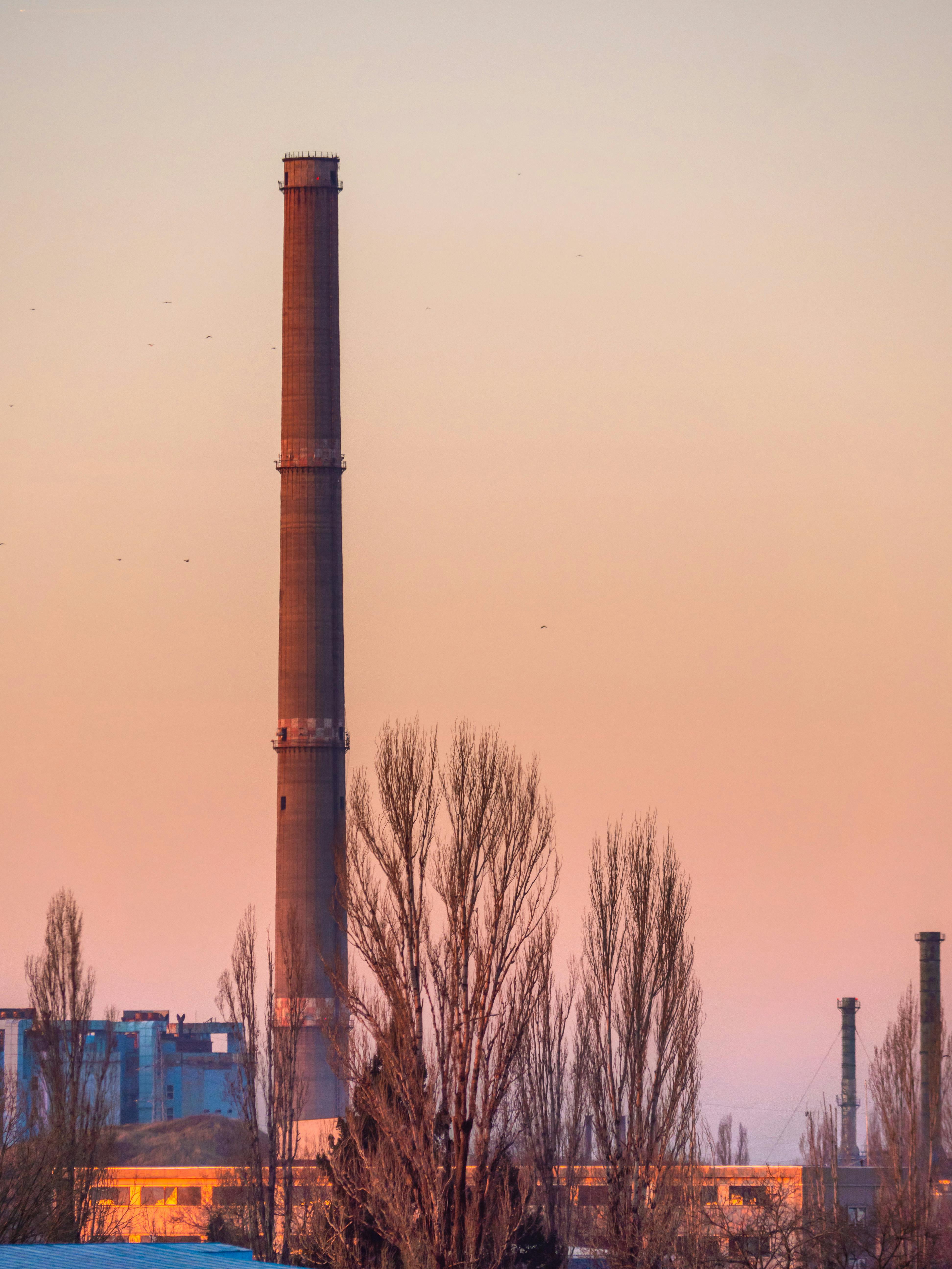 Brown and White Factory Building during Night Time · Free Stock Photo