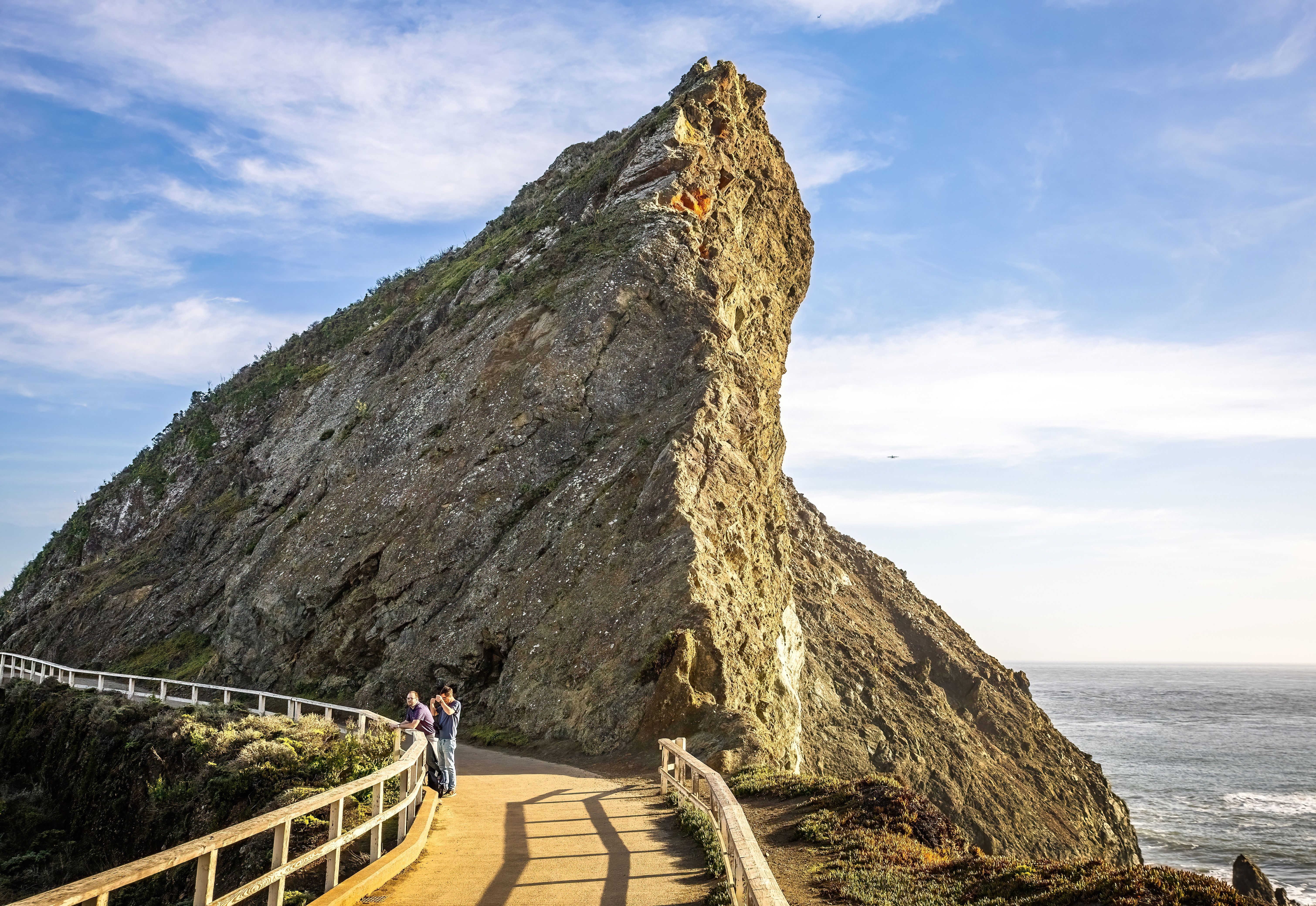 Boardwalk Next to Cliff Rock on Seashore · Free Stock Photo
