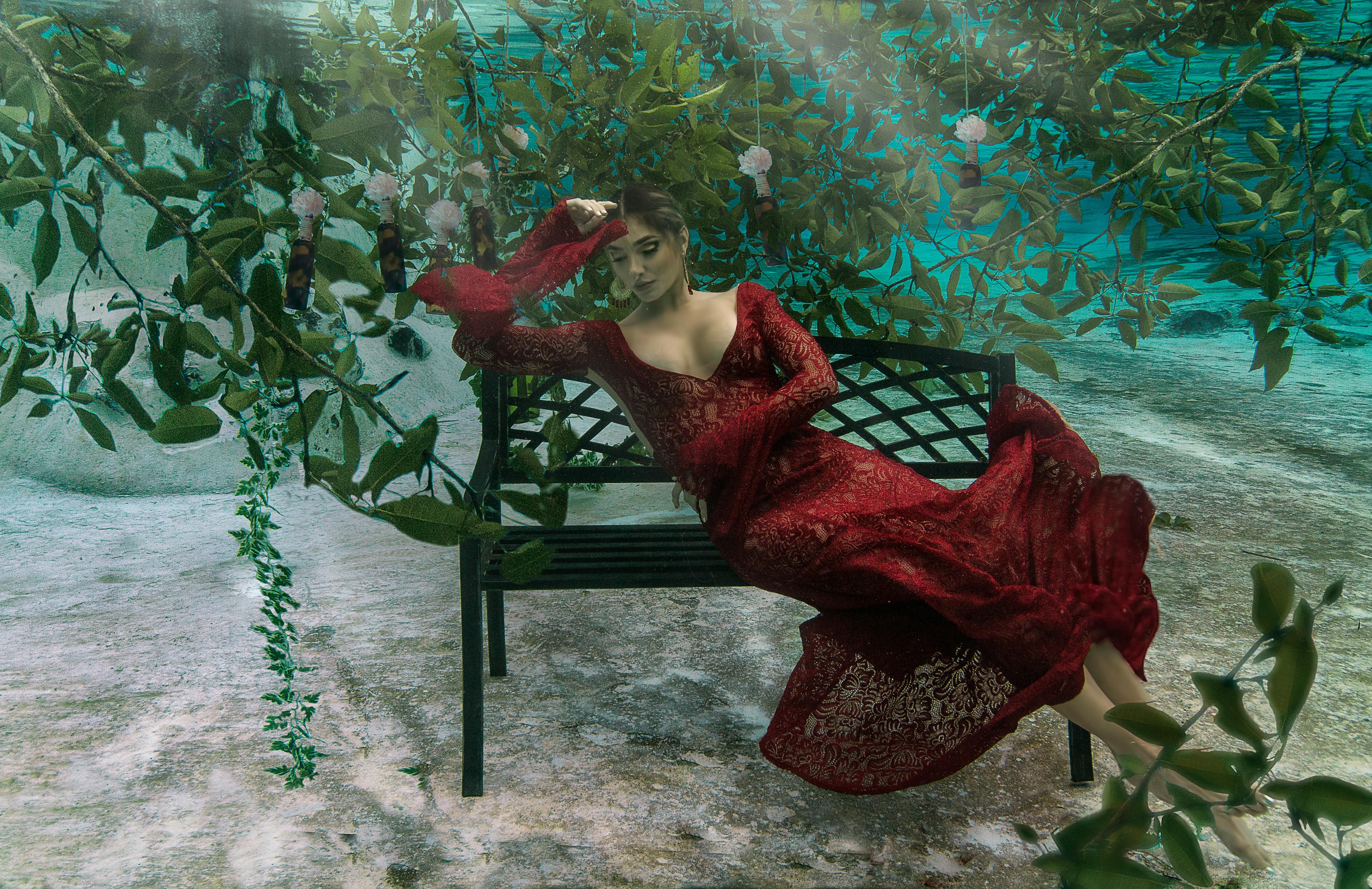 Female Model Wearing a Red Dress Leaning on an Underwater Bench · Free ...