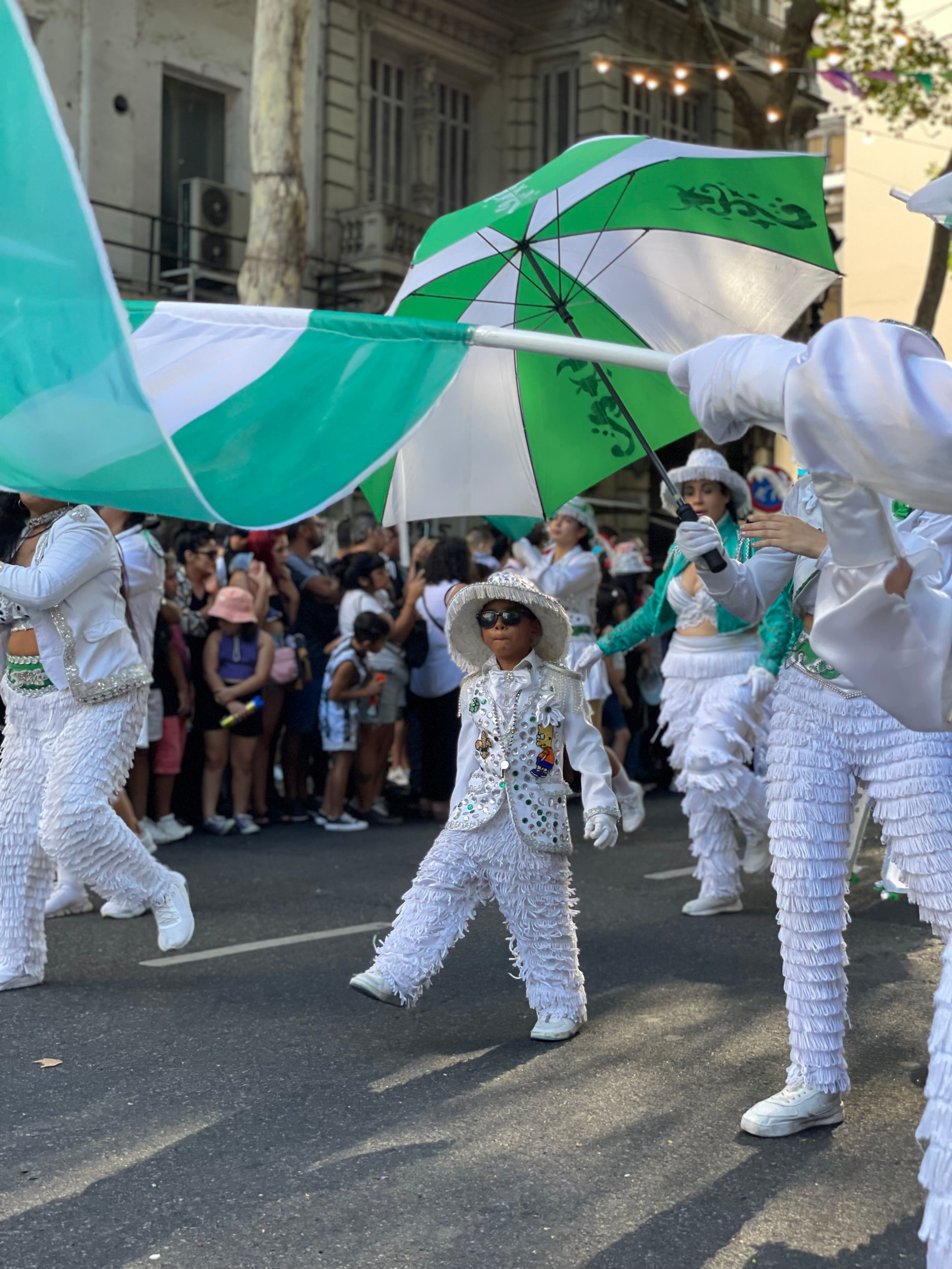 A parade with people dressed in white and green · Free Stock Photo