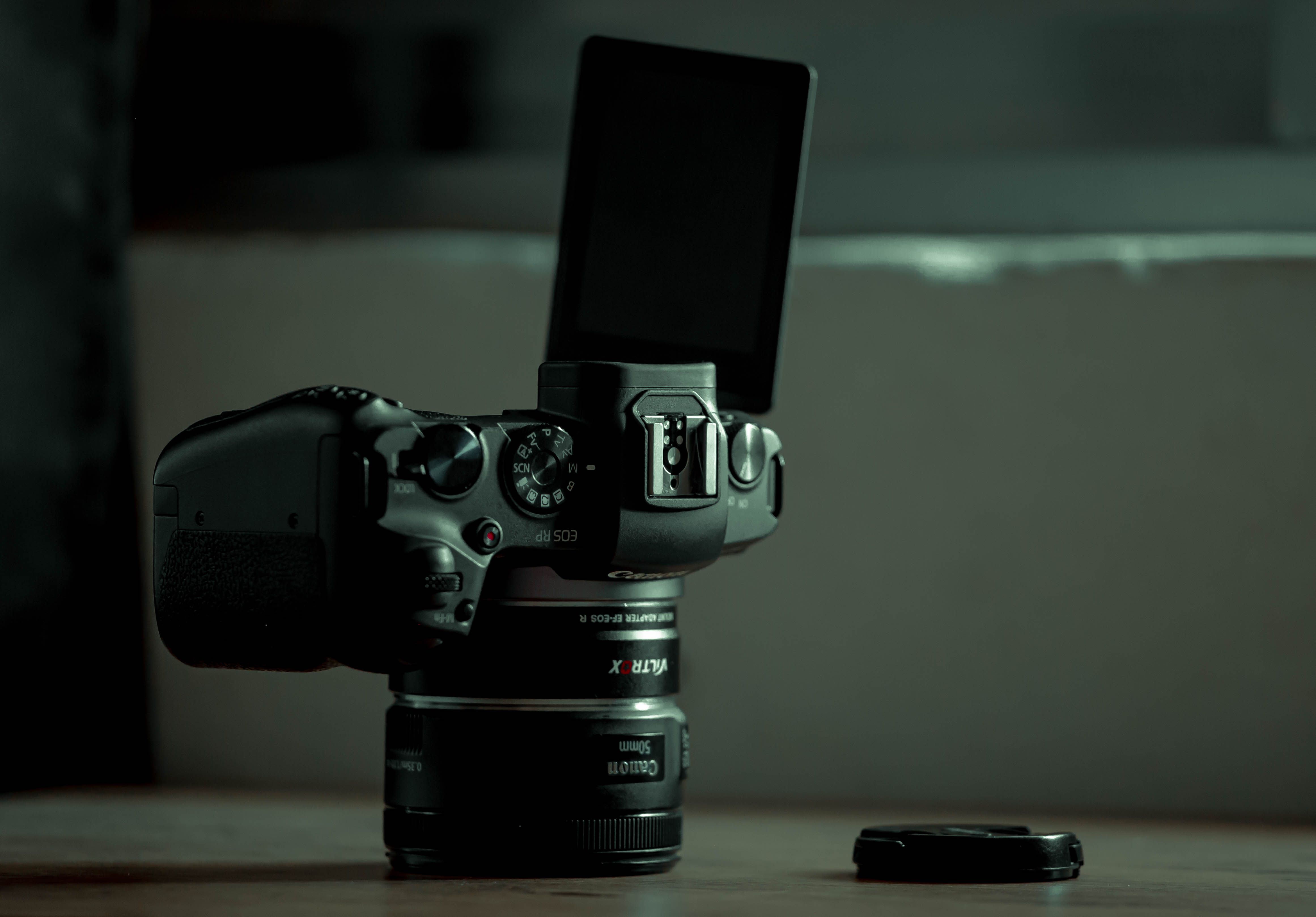 A Branded Digital Camera on a Yellow Surface · Free Stock Photo