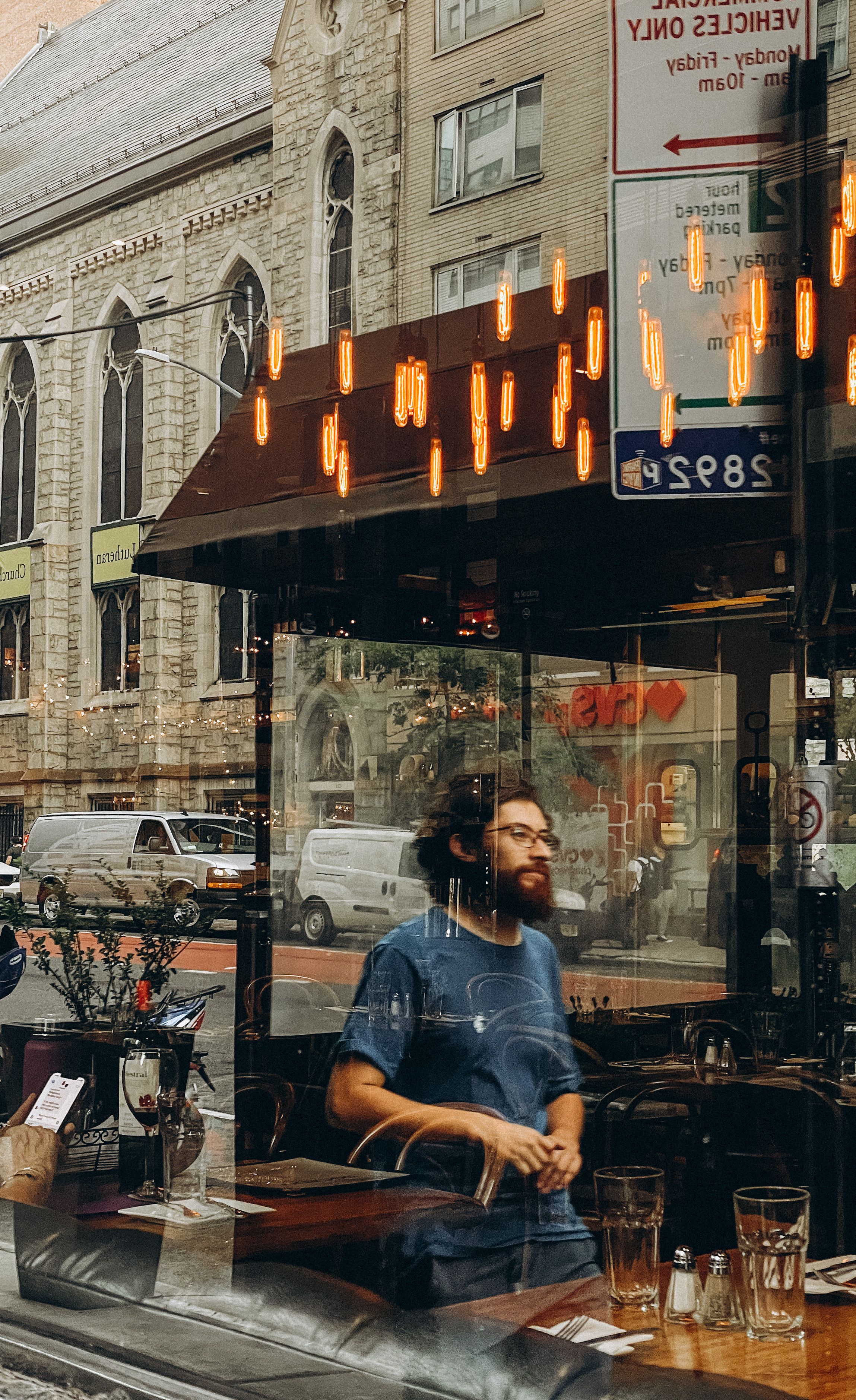 Man Standing in Sidewalk Cafe · Free Stock Photo