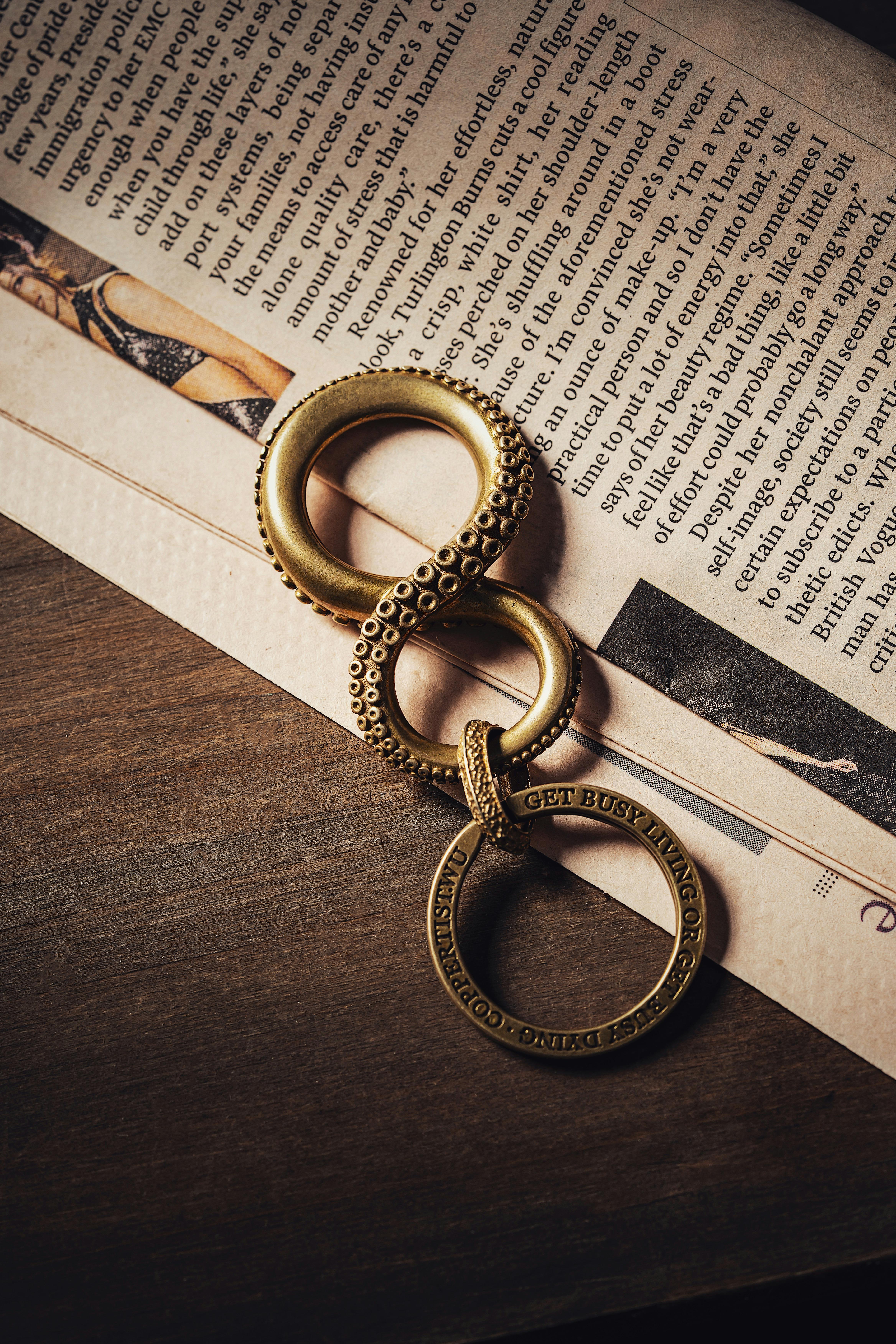 Octopus Infinity Keychain on Newspaper · Free Stock Photo