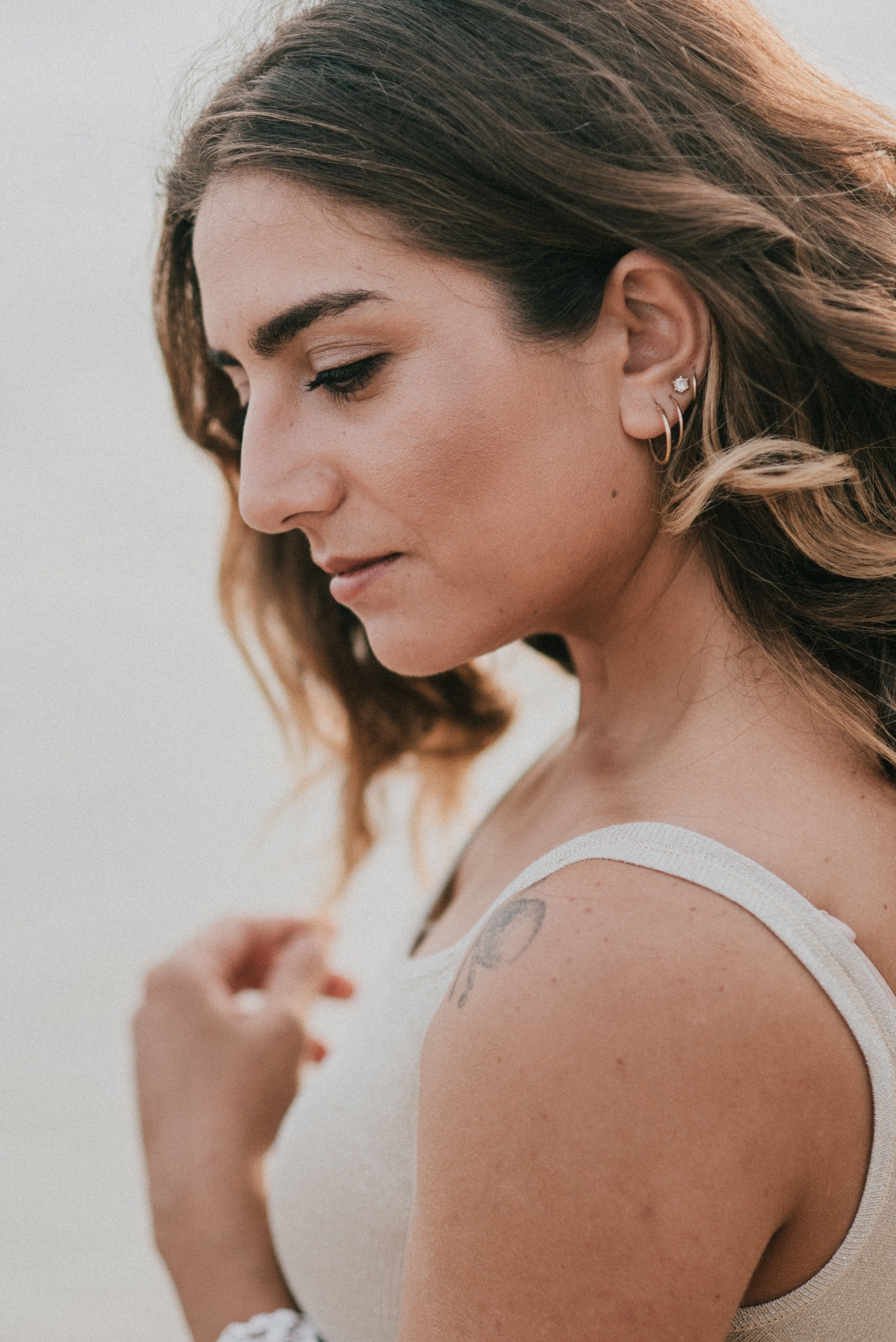 Photo of a Young Woman in a White Top Standing Outside · Free Stock Photo
