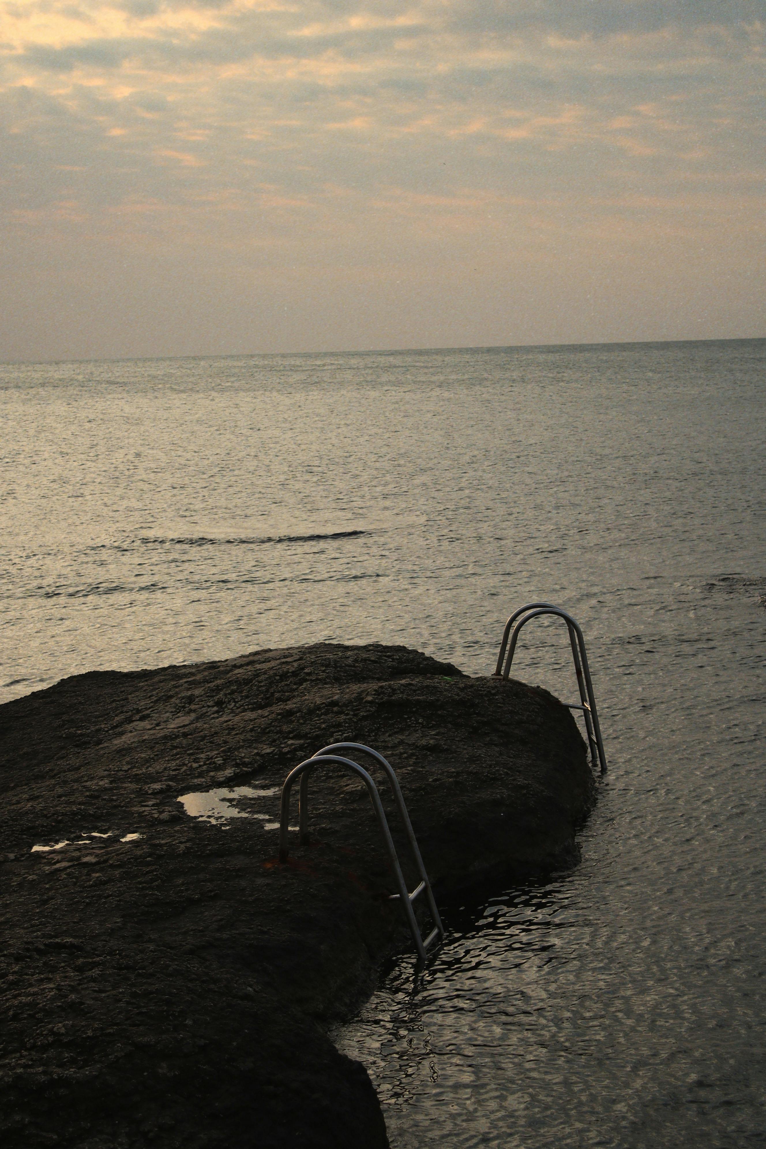Ladders on Rocks on Sea Shore · Free Stock Photo