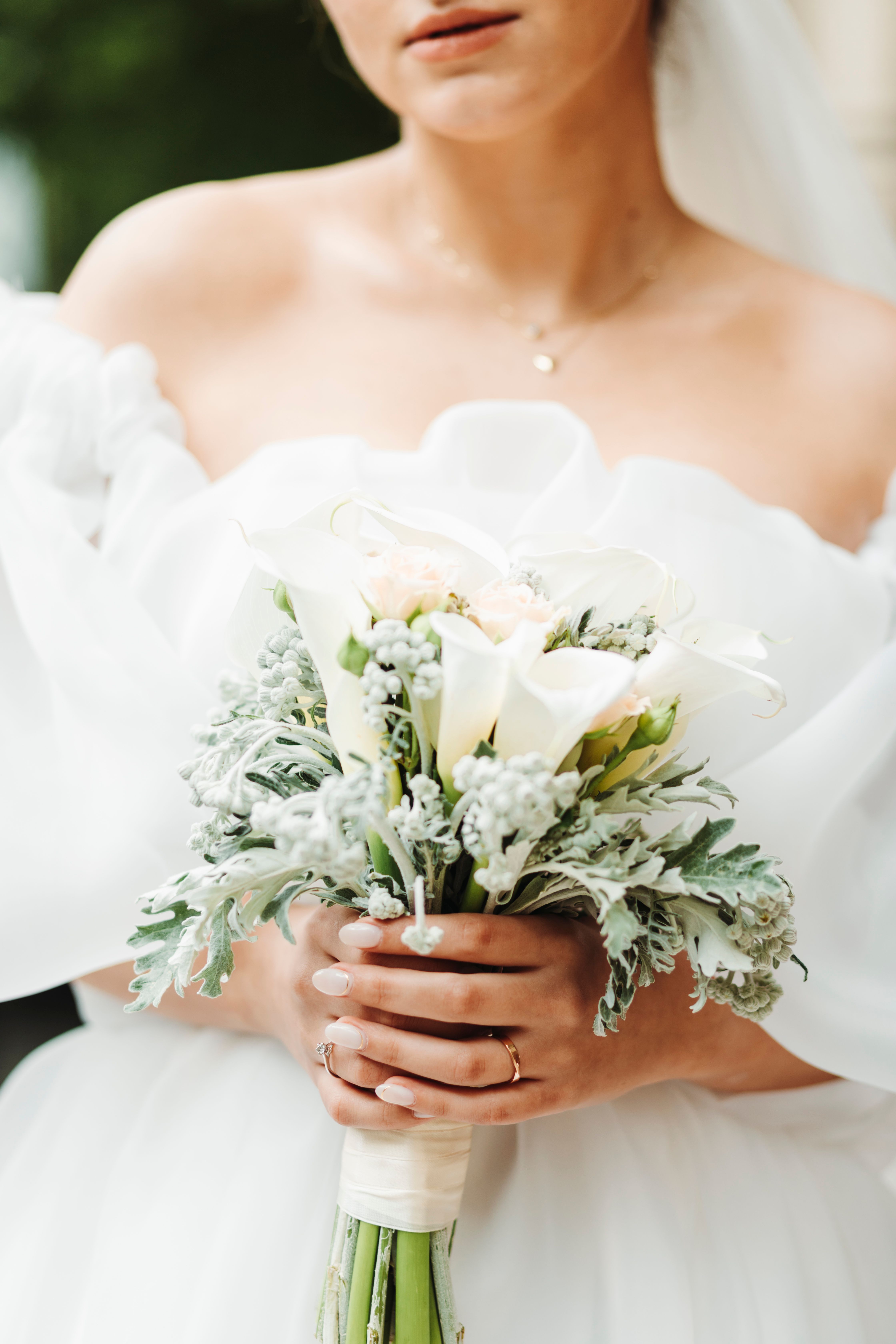 Bride Holding Bouquet of White Flowers in Hands · Free Stock Photo