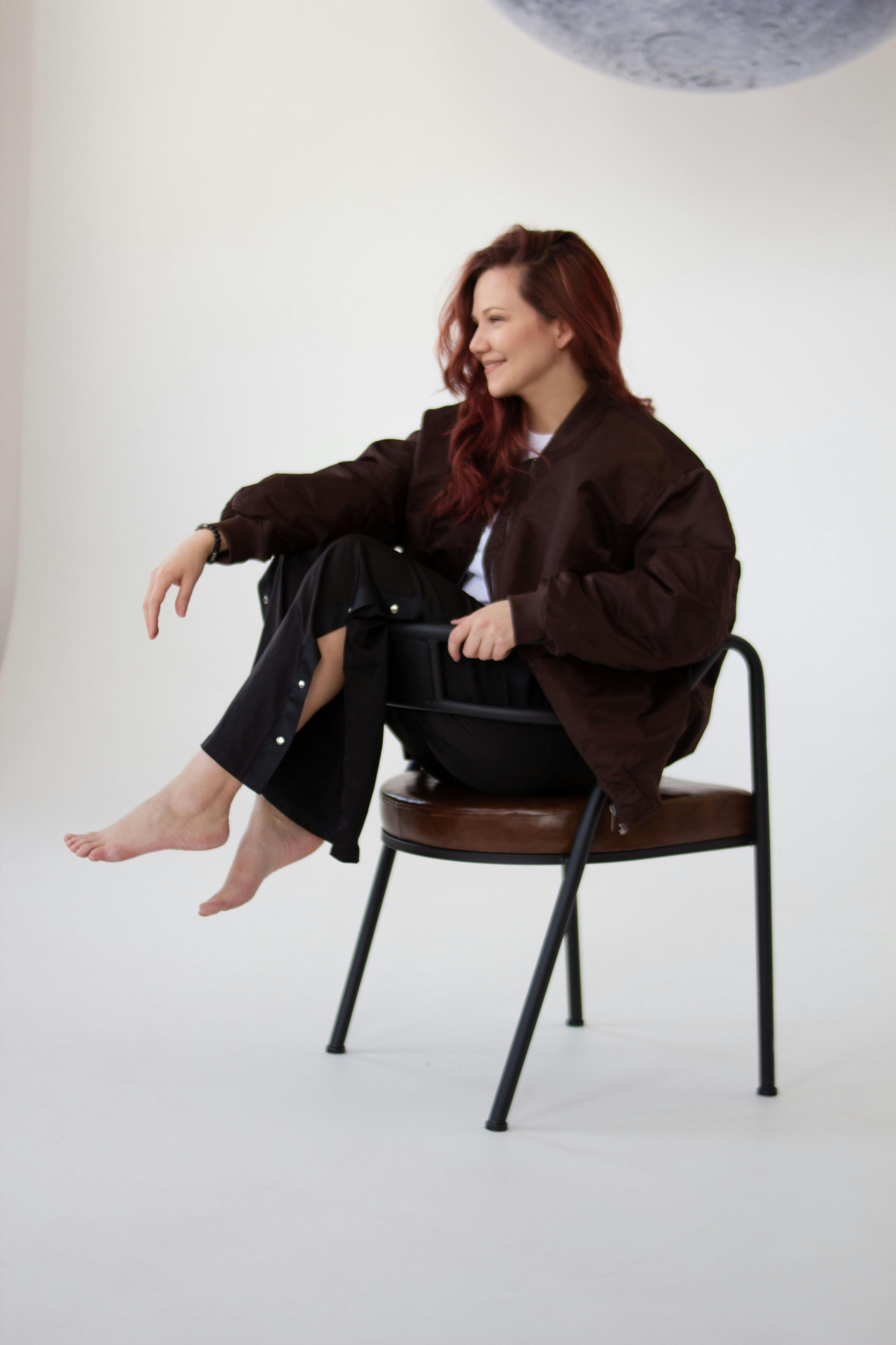 Woman Sitting on the Chair Backward with her Feet in the Air · Free ...