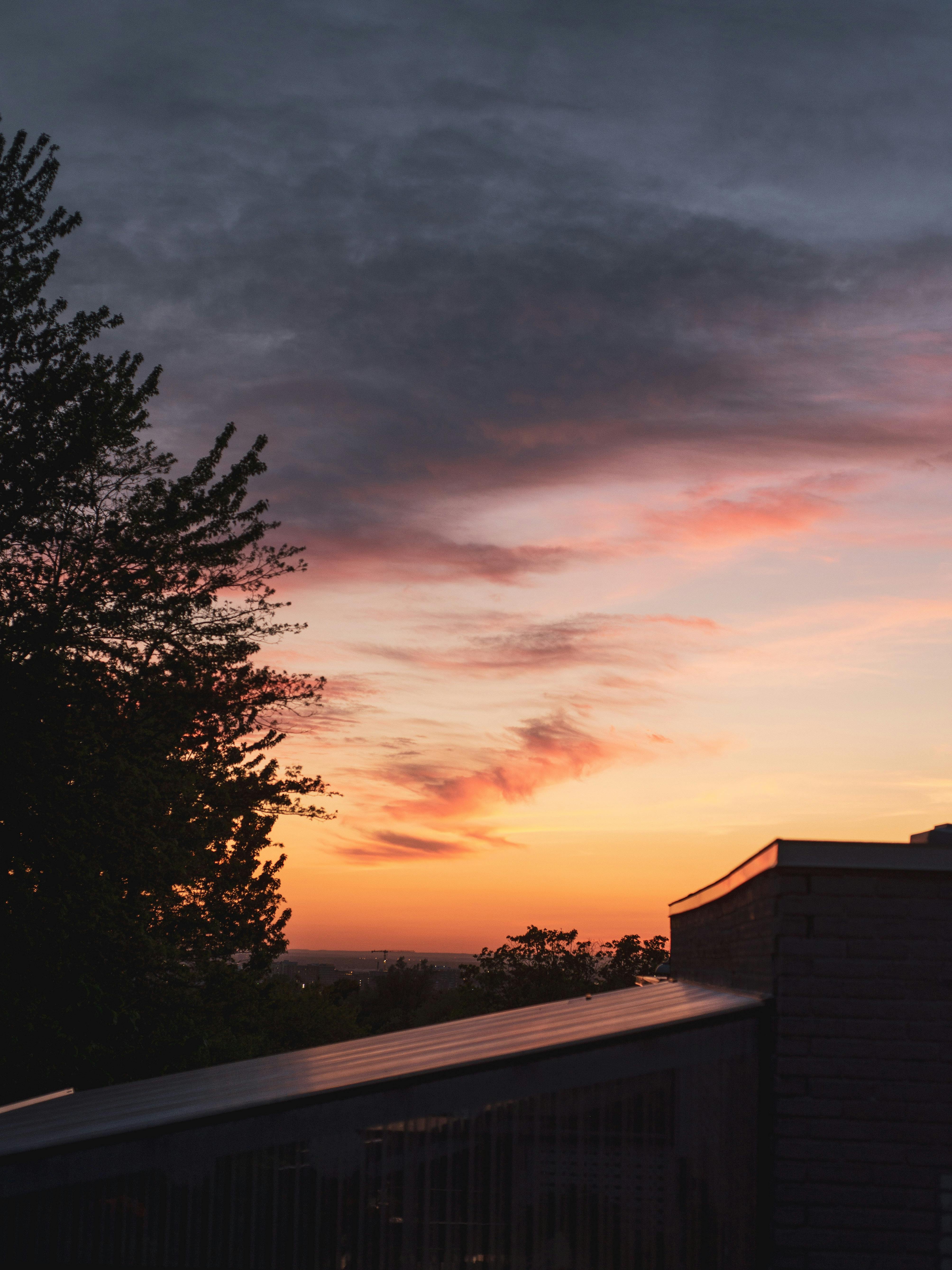 Cloudy Sky at Sunset Over the Rooftop · Free Stock Photo