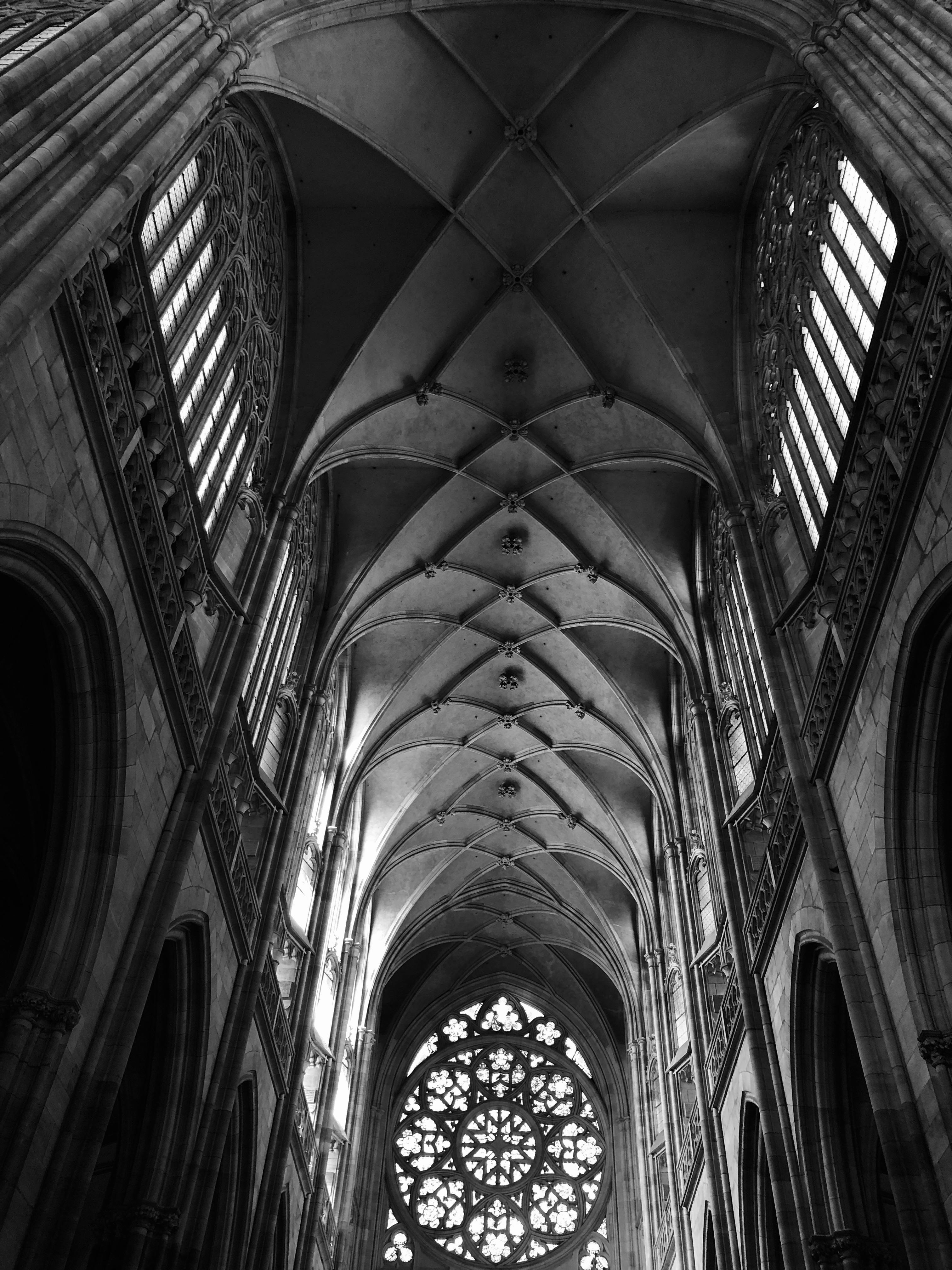 The interior of a cathedral with a large window · Free Stock Photo