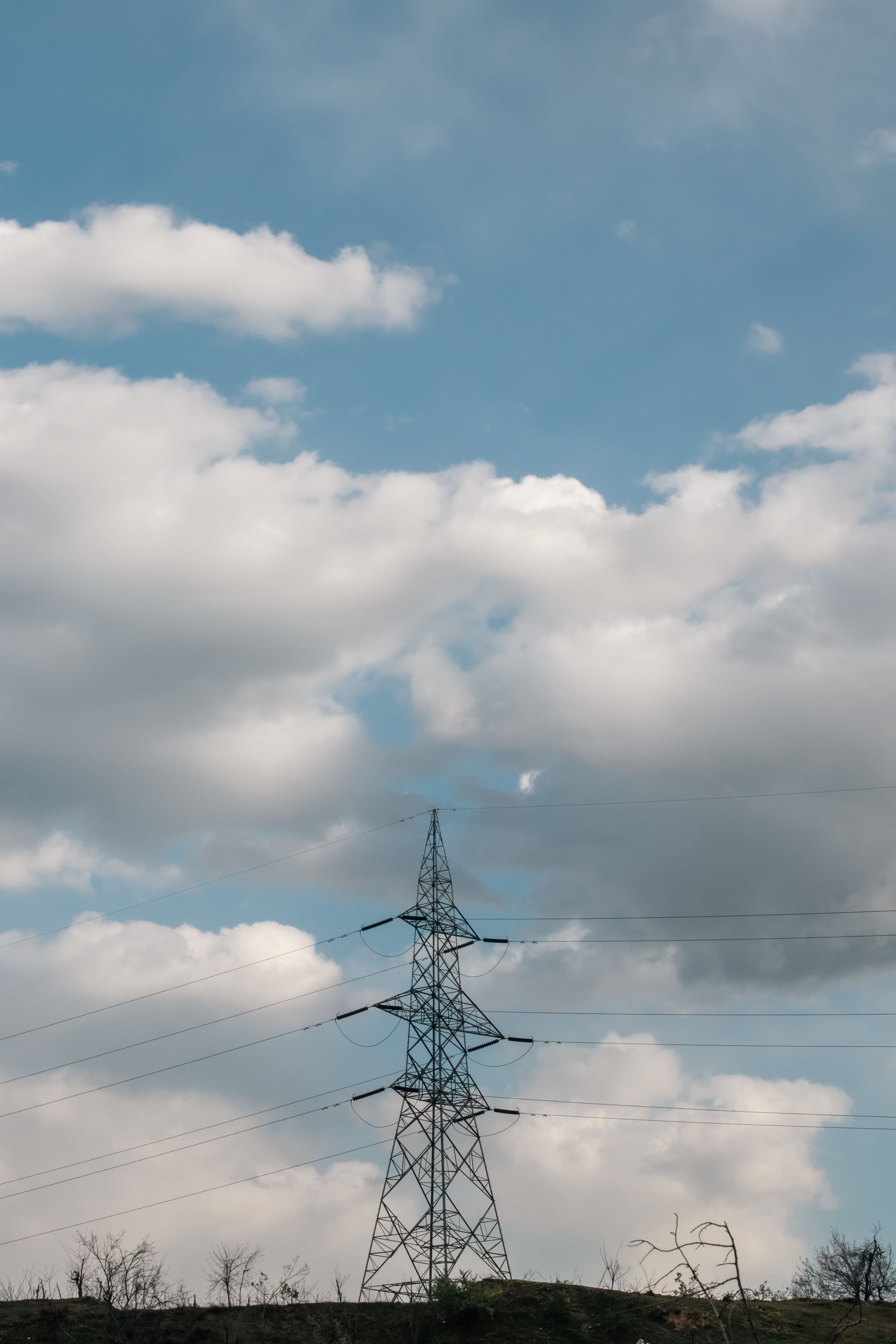 Electricity Pylon under Fluffy White Clouds · Free Stock Photo