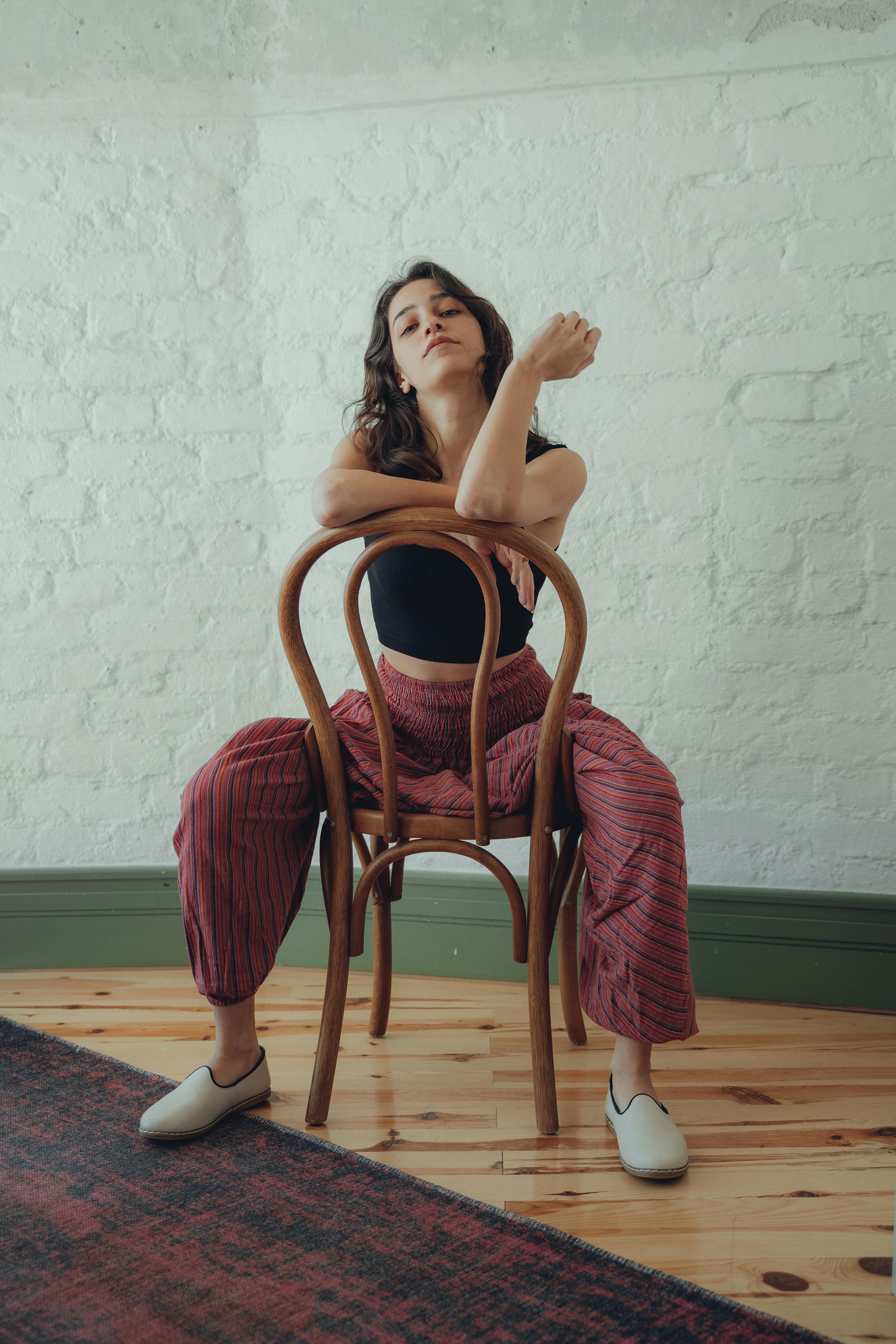 Woman Sitting Backwards on Wooden Chair · Free Stock Photo