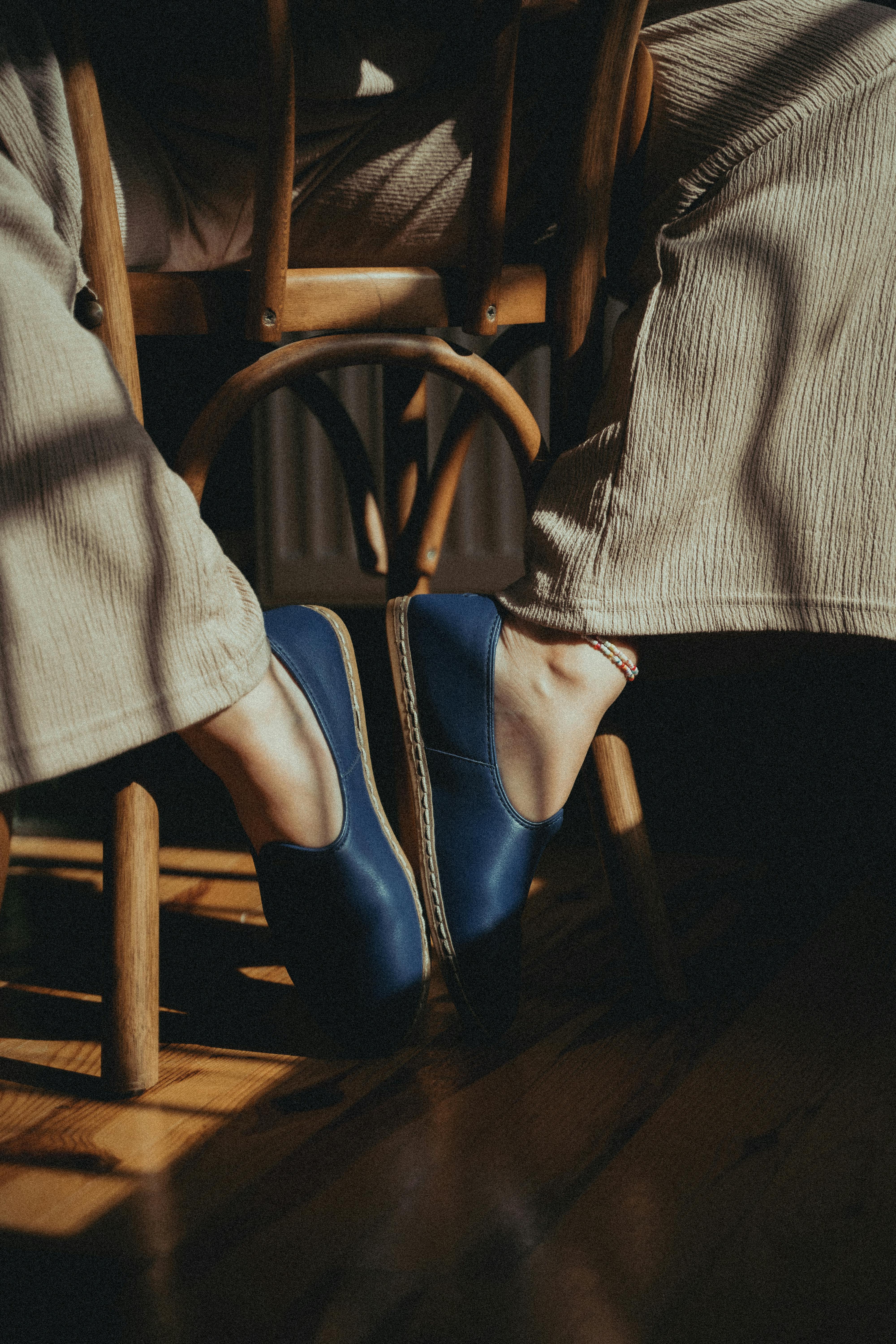 Shoes of Person Sitting on Chair · Free Stock Photo