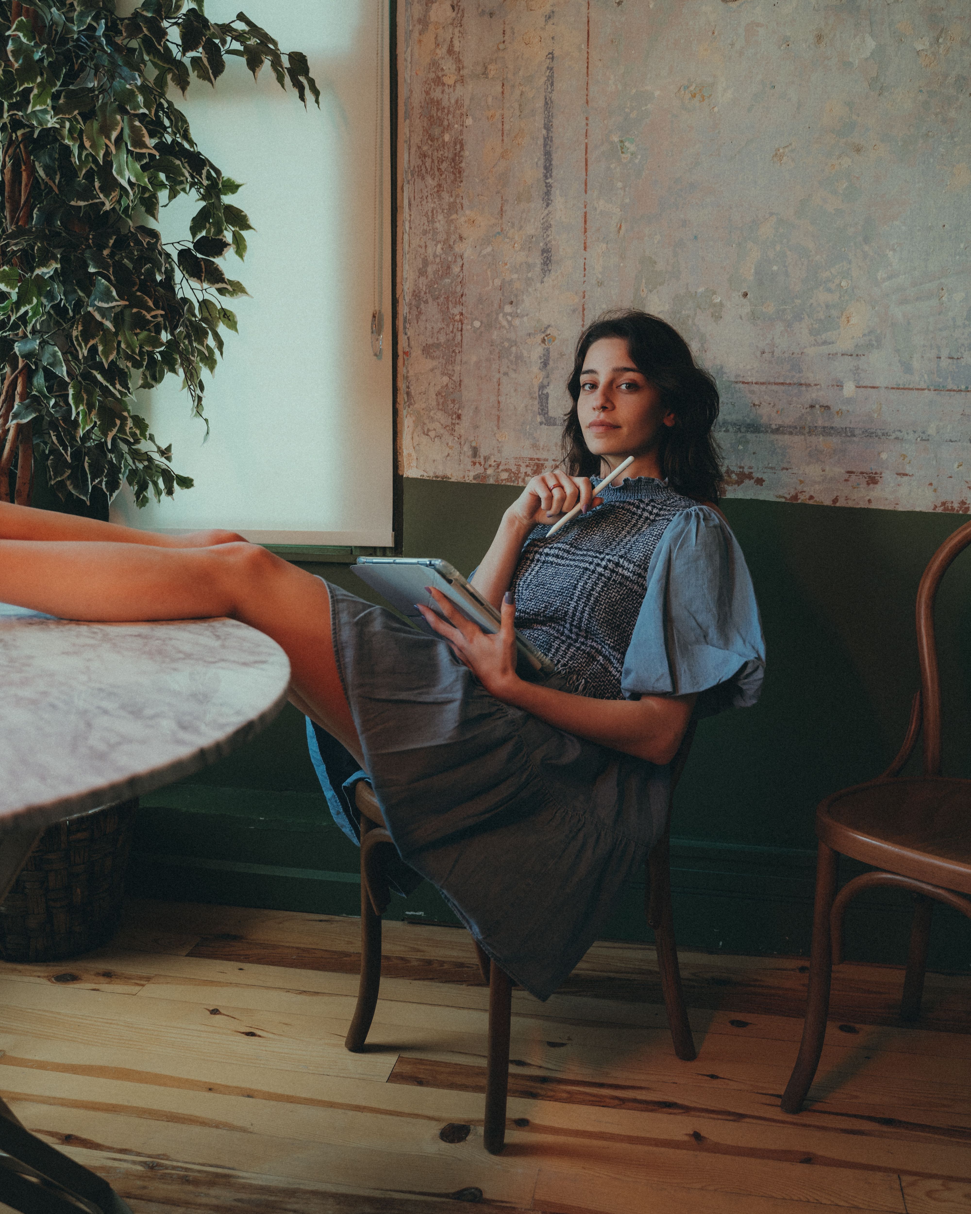 Young Woman Sitting with Her Legs Up on a Table · Free Stock Photo
