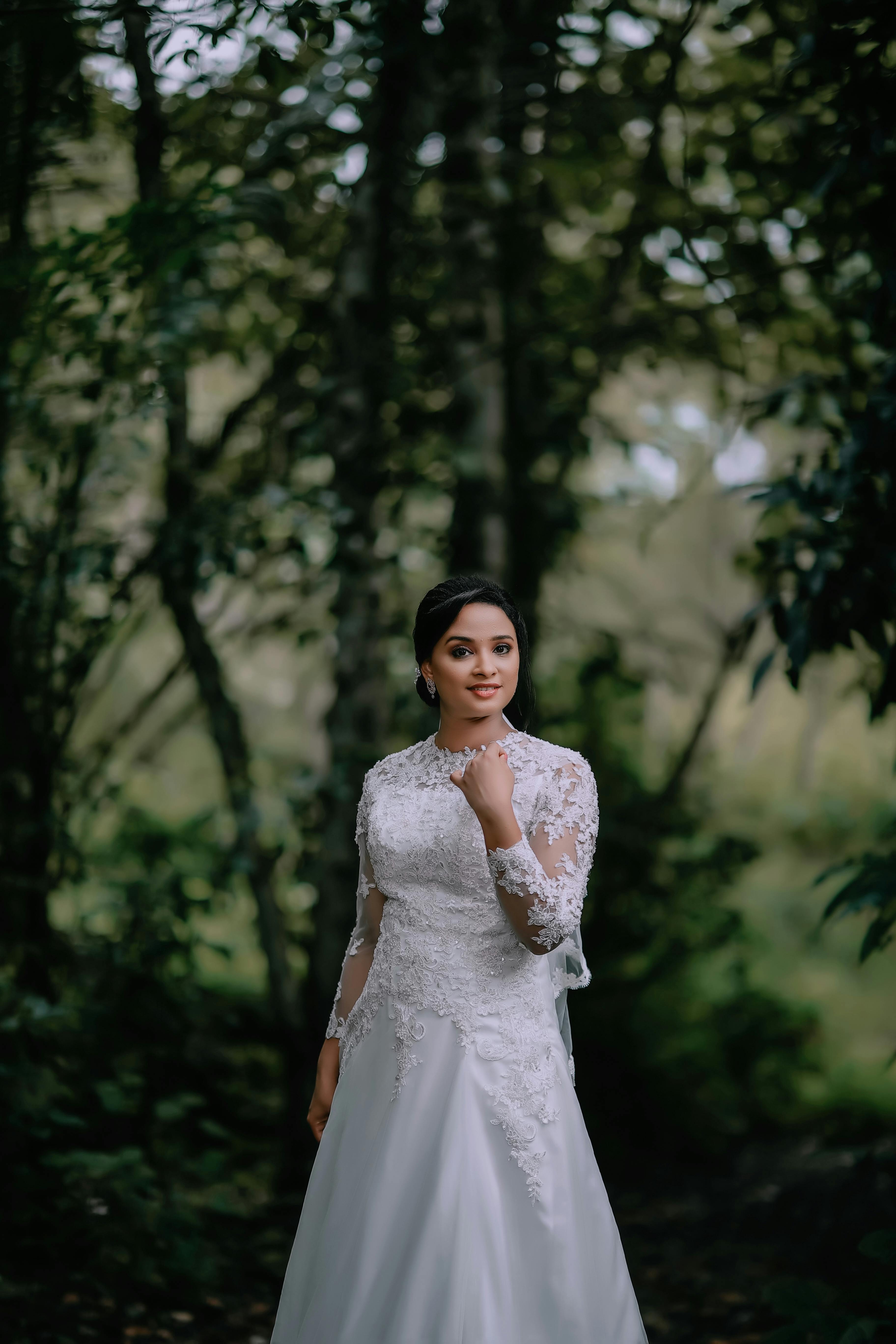 Woman in a White Dress and Trainers Standing on the Lakeshore · Free ...