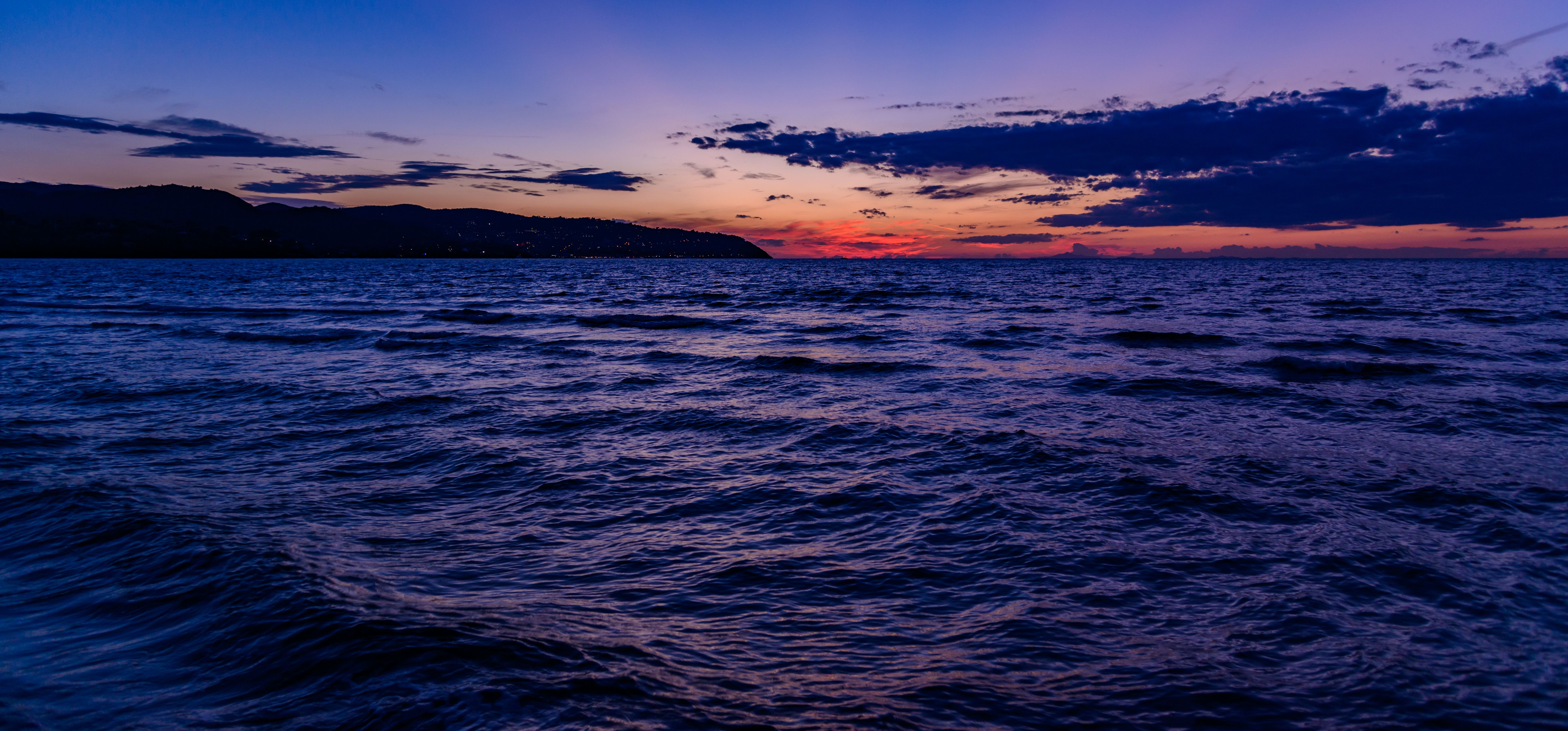 Photo of Sunset over Large Body of Water · Free Stock Photo
