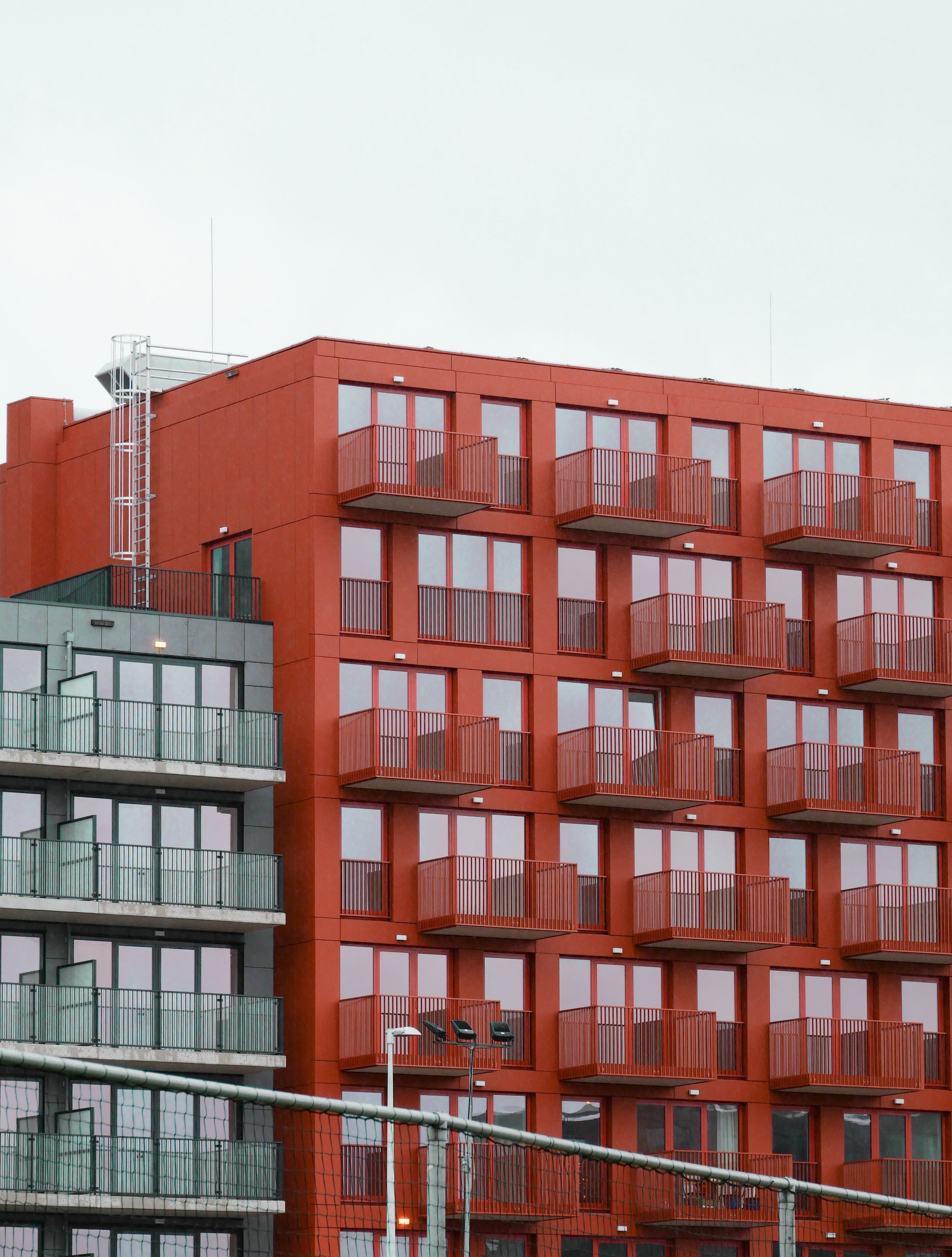 Facade of a Red Apartment Building · Free Stock Photo