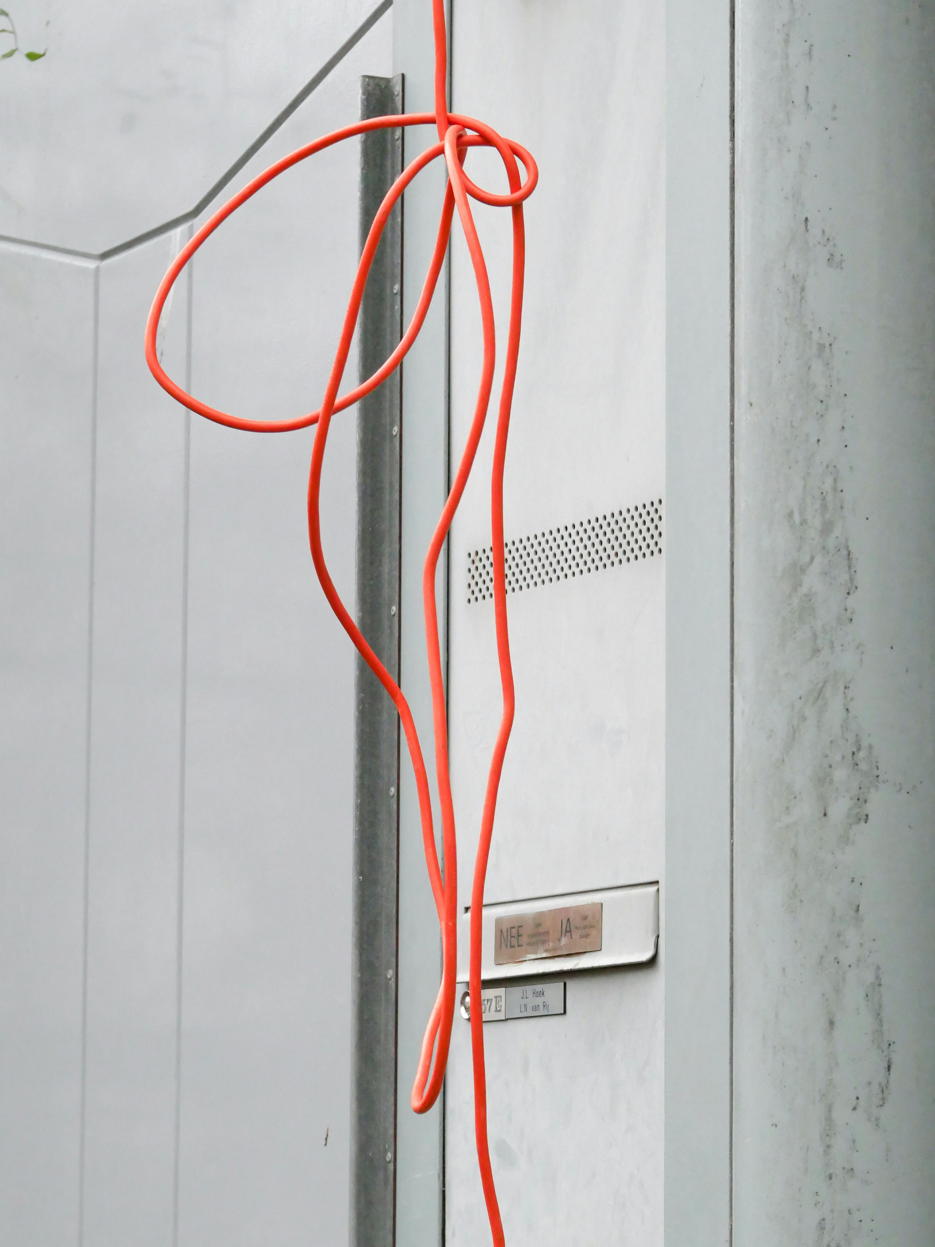 Red Cable Sticking Out of Wall · Free Stock Photo