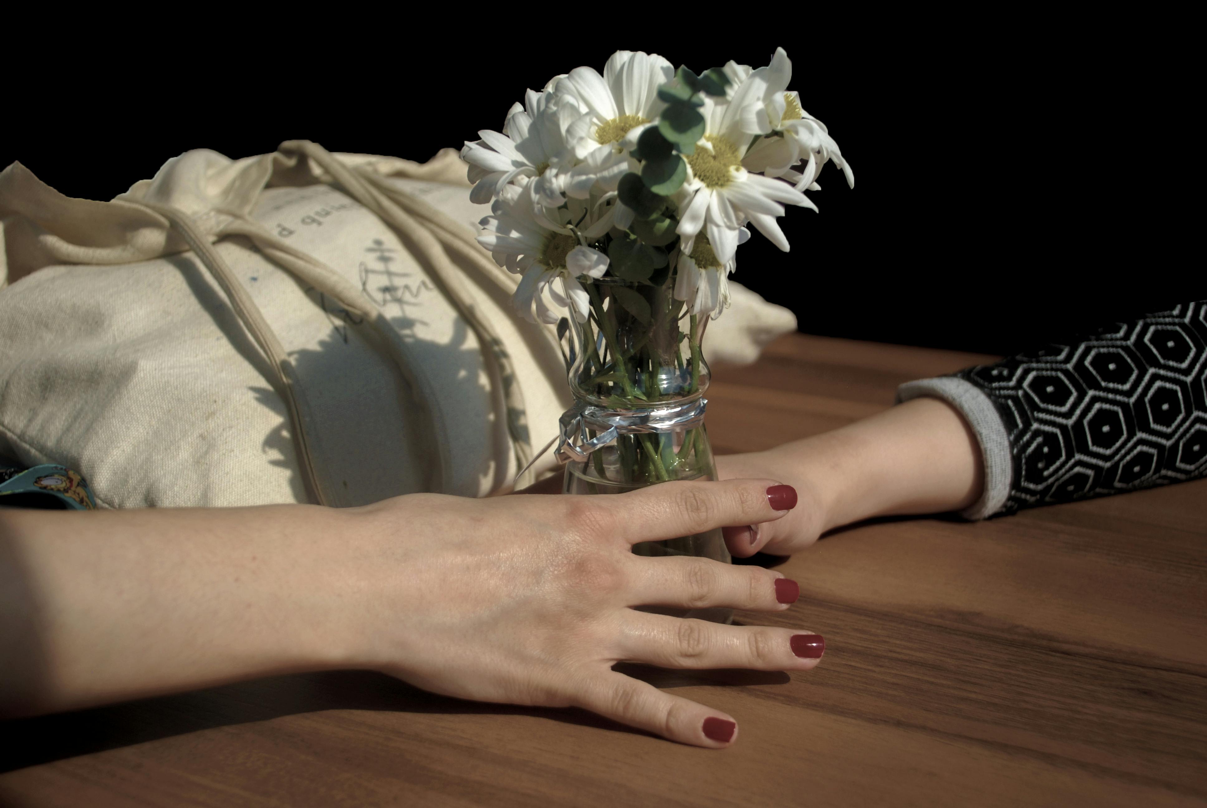 Women Holding Hands on Table · Free Stock Photo
