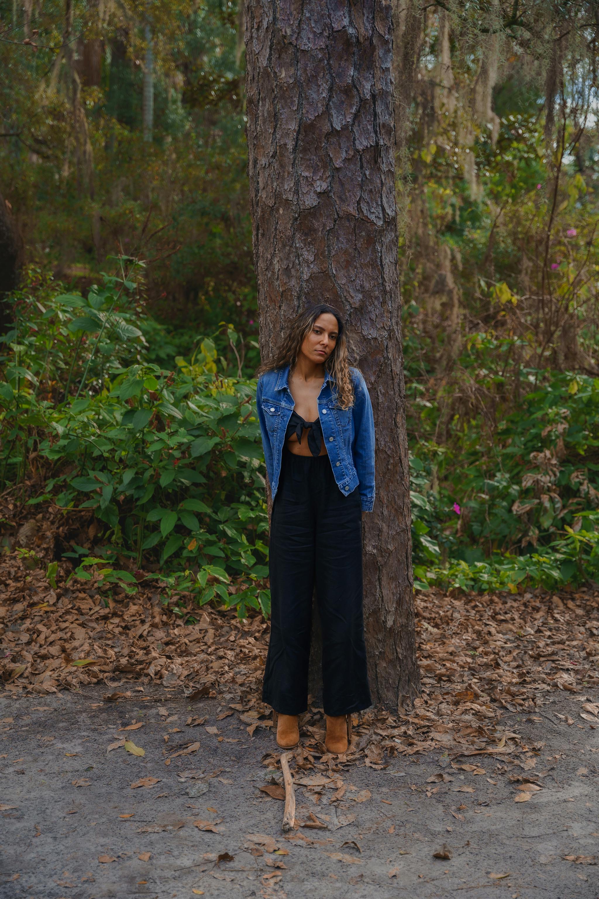 A Fashionable Woman Standing next to a Tree · Free Stock Photo